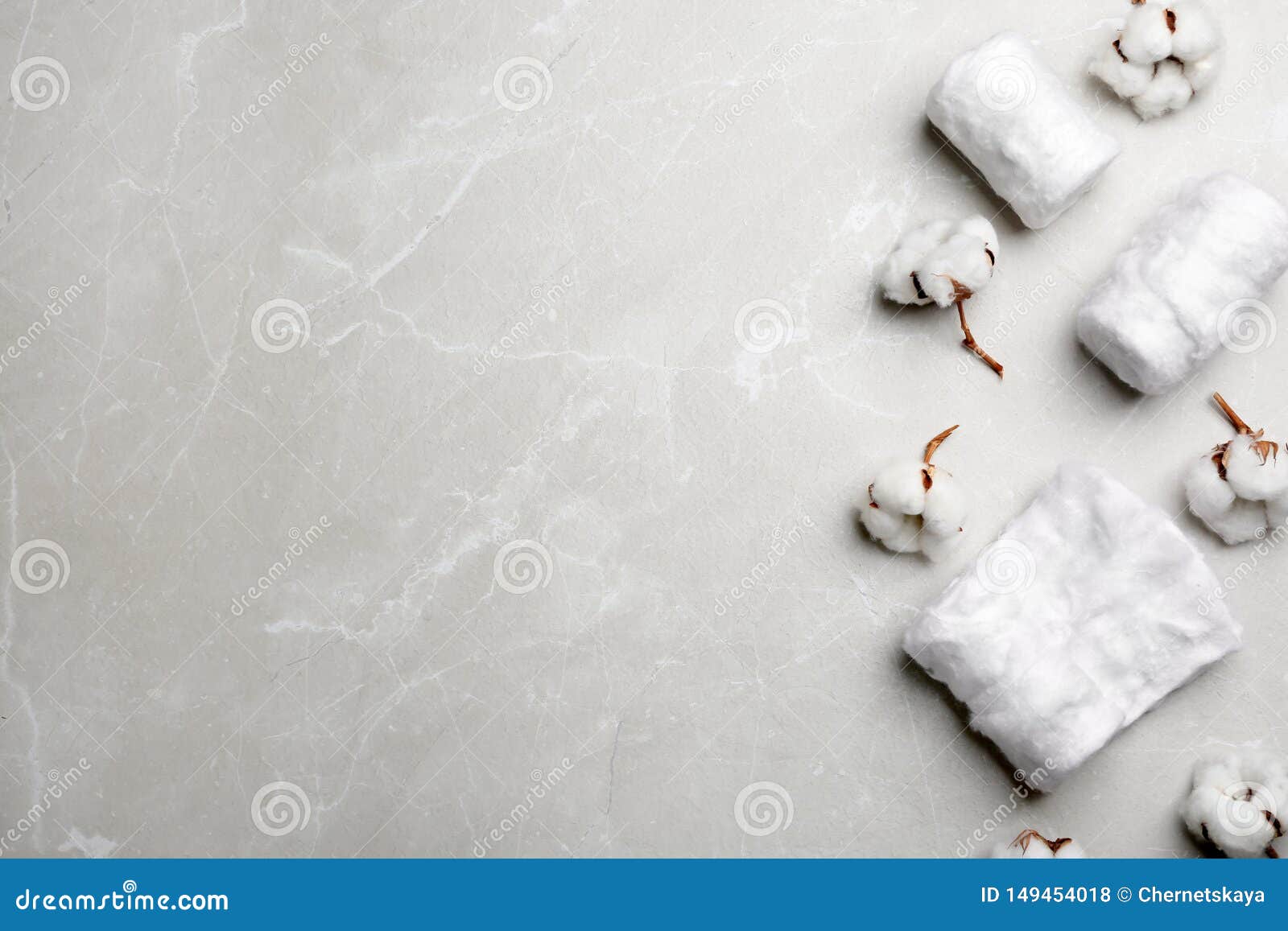 Flat Lay Composition with Fluffy Cotton Rolls and Flowers on Gray ...