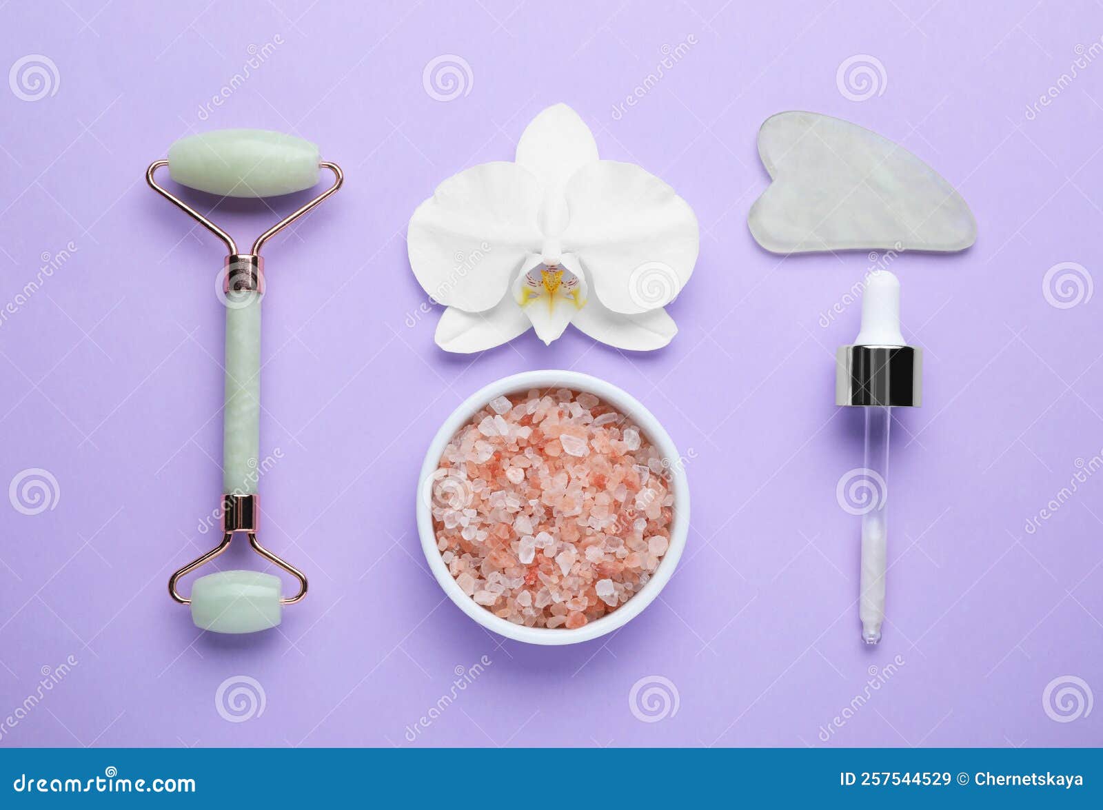Flat Lay Composition with Gua Sha Stone and Face Roller on Violet ...