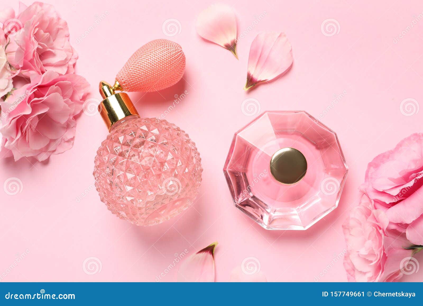 Flat Lay Composition with Perfume Bottles and Flowers on Pink ...
