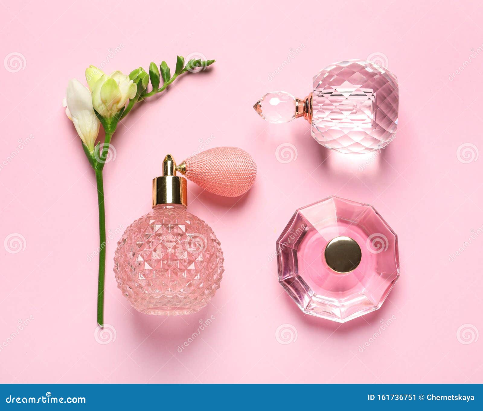 Flat Lay Composition with Perfume Bottles and Flowers on Pink ...