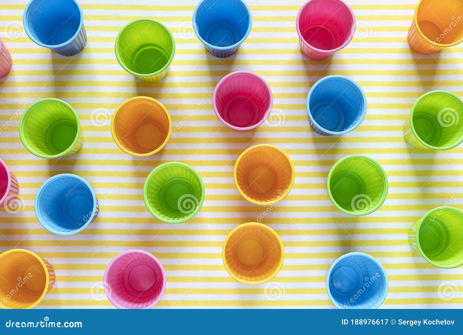 Flat Lay of Multi-colored Plastic Cups on a Yellow Background. Concept ...