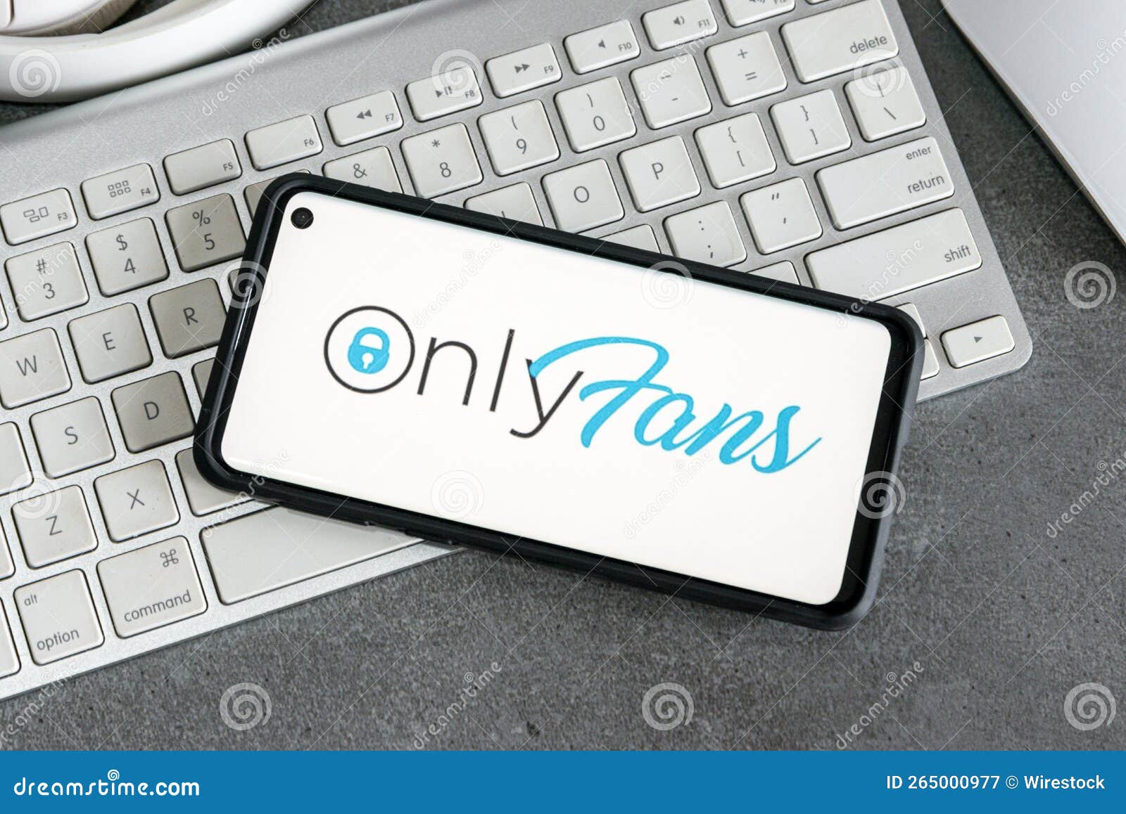 Flat Lay of a Smartphone with an OnlyFans Logo on it Against a White ...