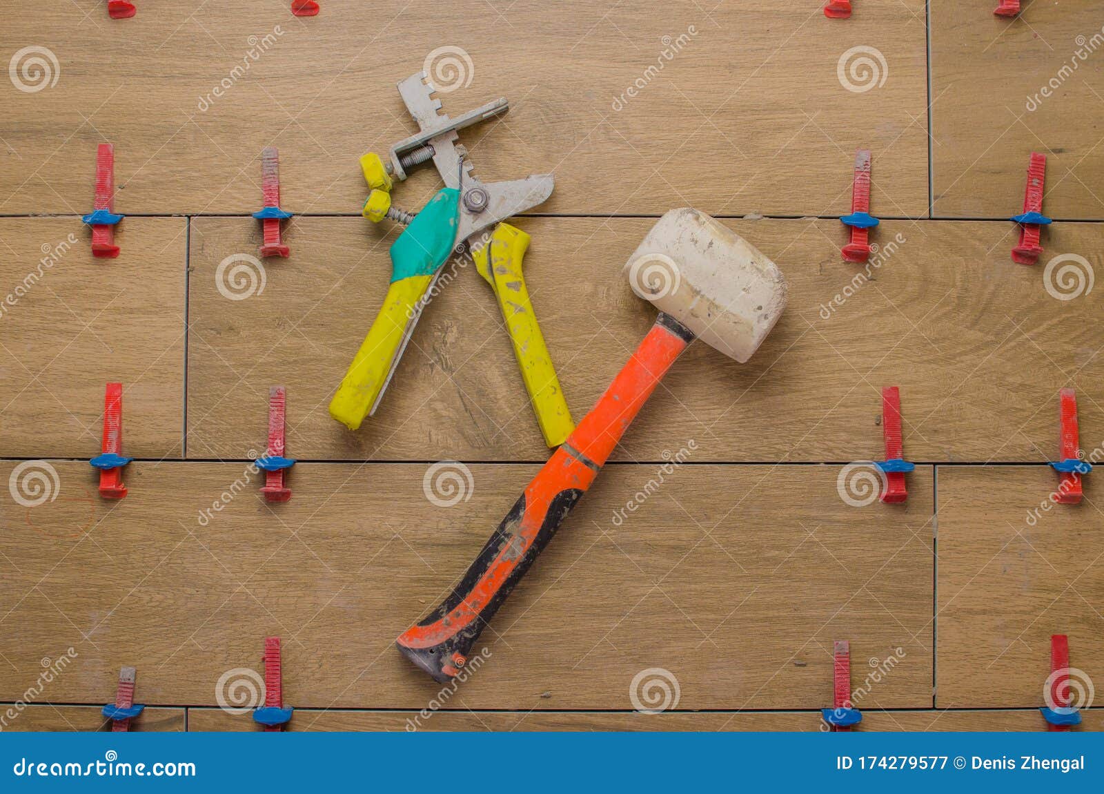 Flat Pattern with Red Rubber Hammer Laying Tile. Ceramic Tile in Wood ...