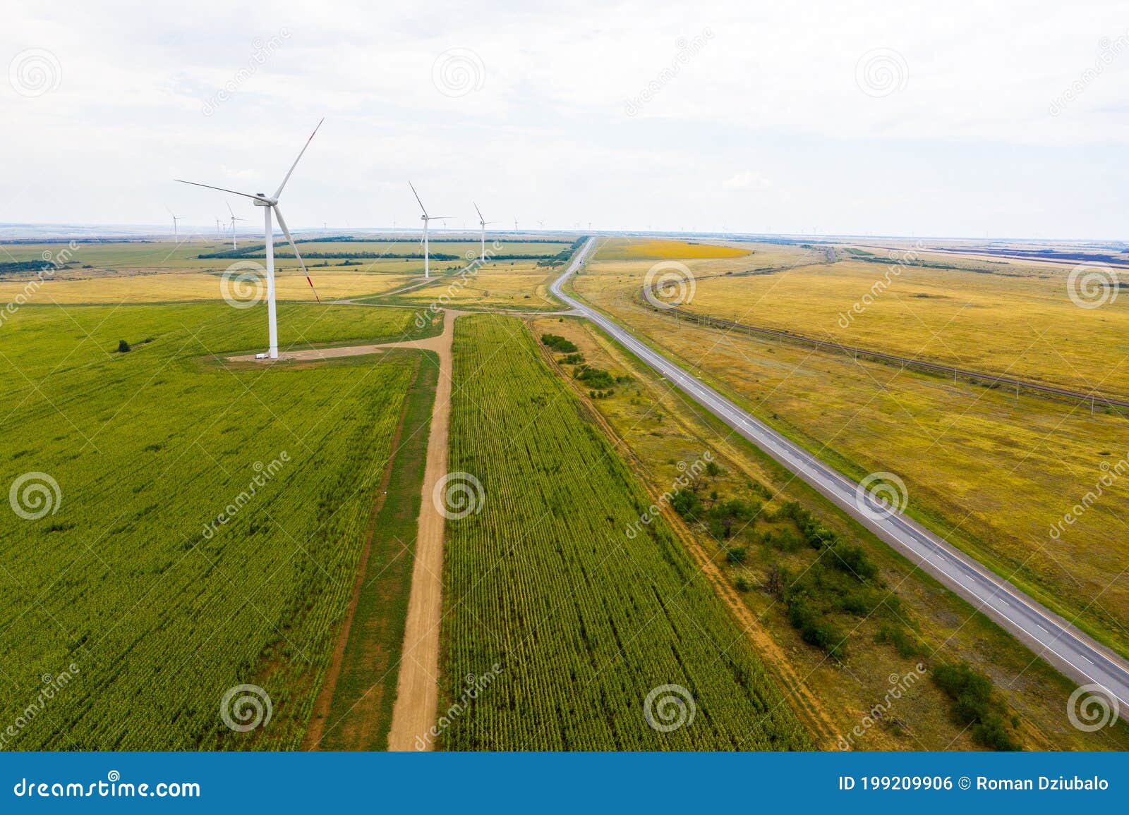 Flat Terrain with Lots of Wind Turbines in the Fields and a Highway ...