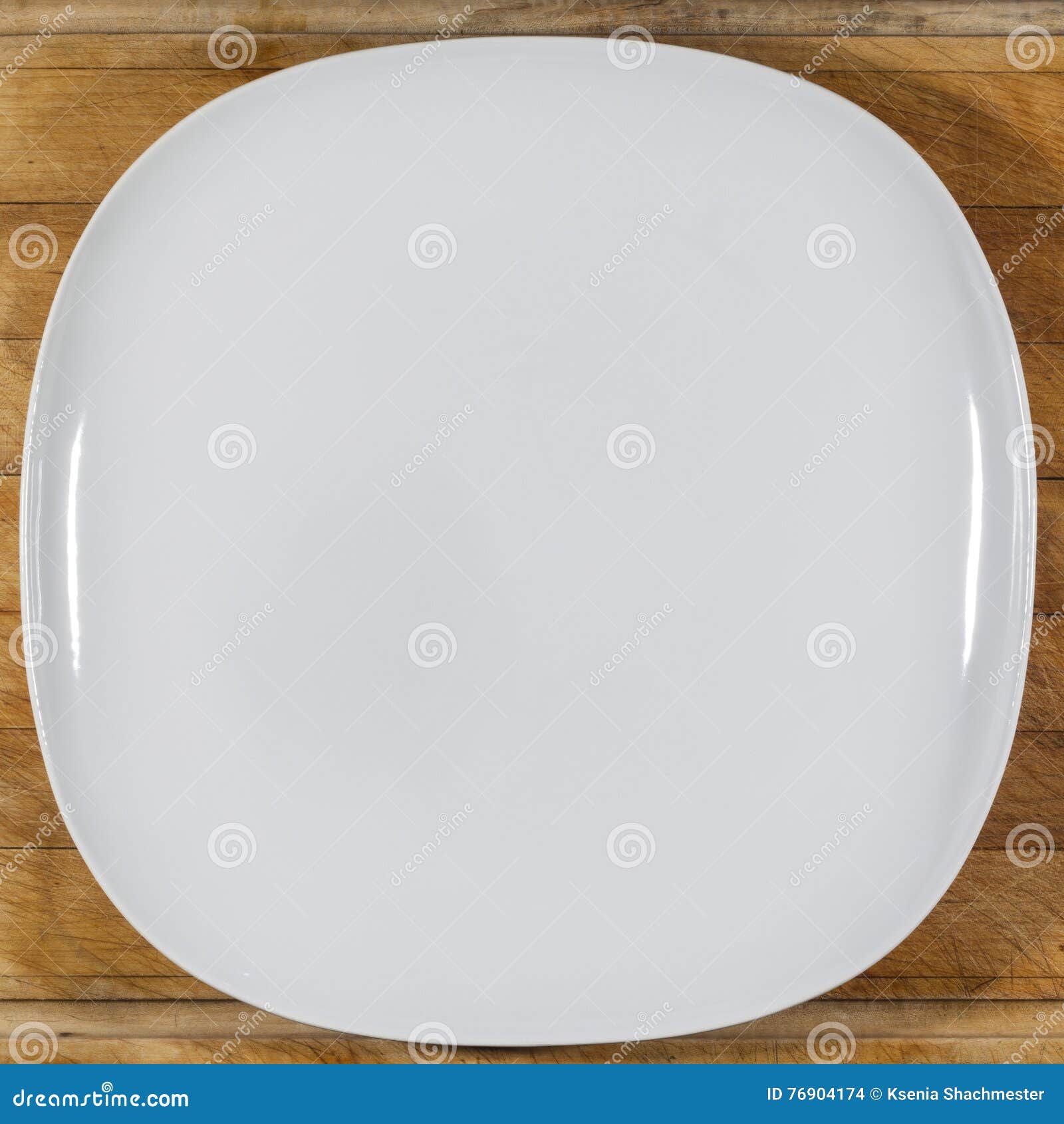 Flat White Square Plate on Wooden Cutting Board from Above Stock Photo ...