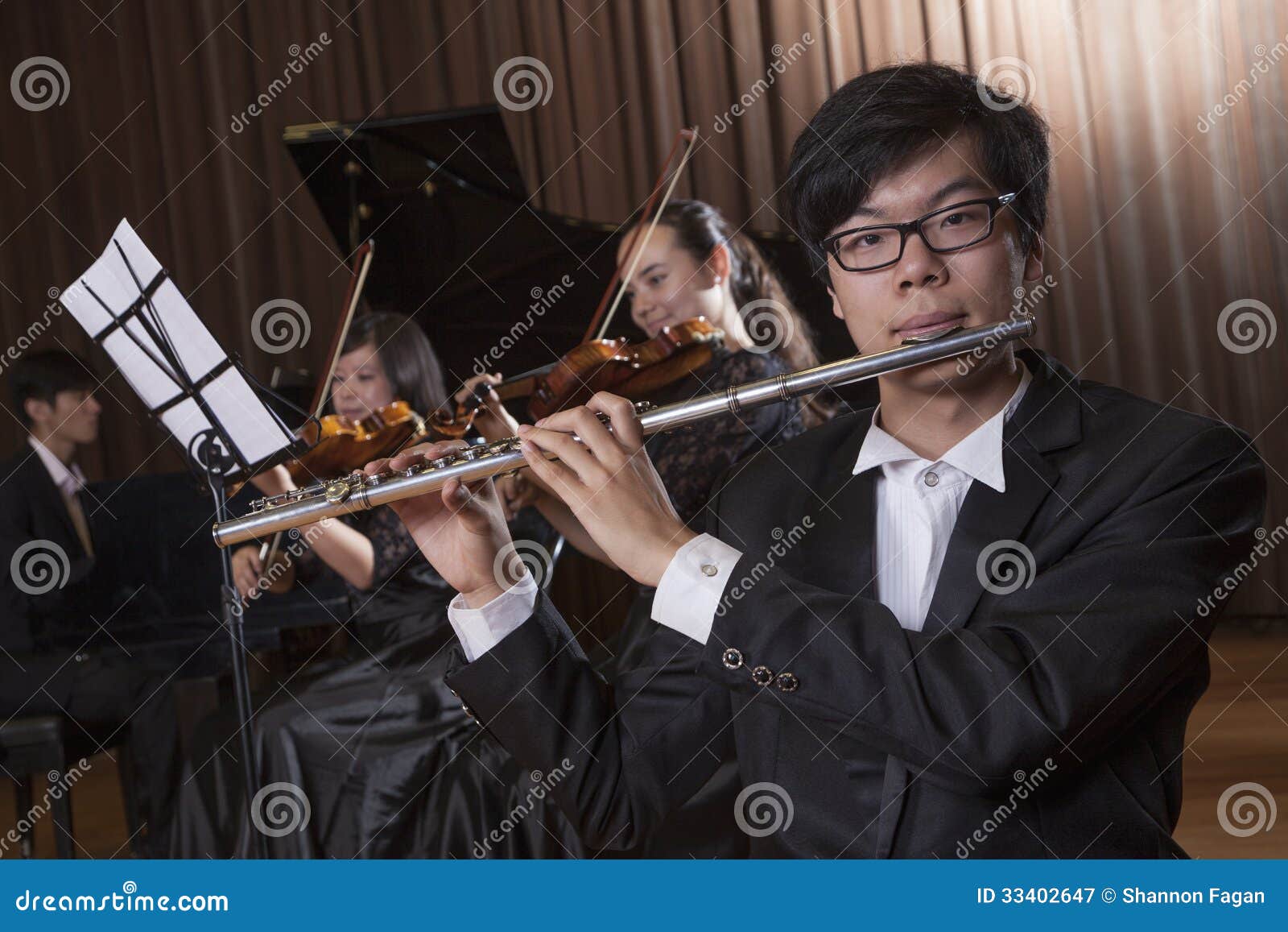 Flautist Holding and Playing the Flute during a Performance, Looking at ...