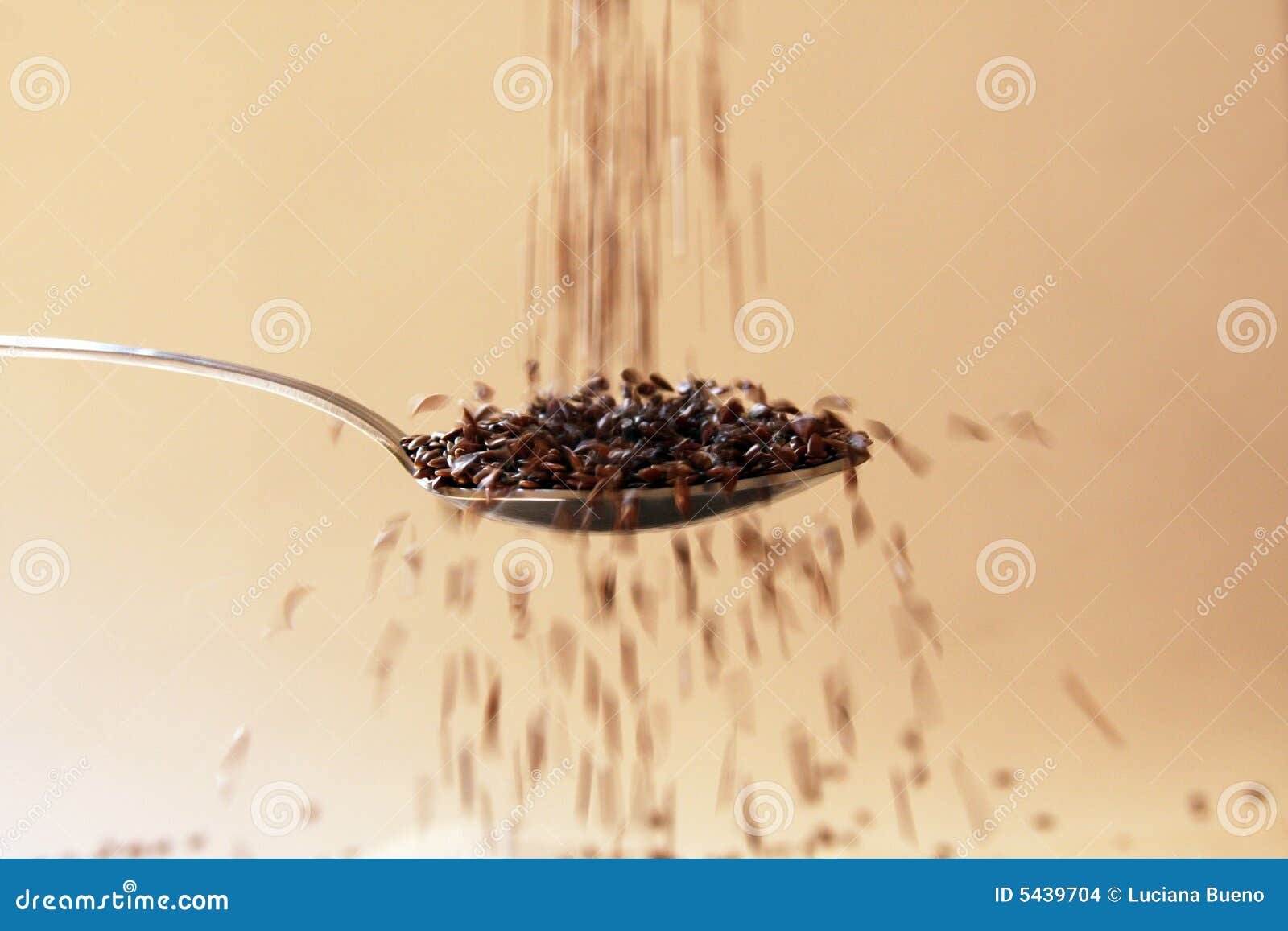 Flaxseed falling in spoon stock photo. Image of vitamins - 5439704