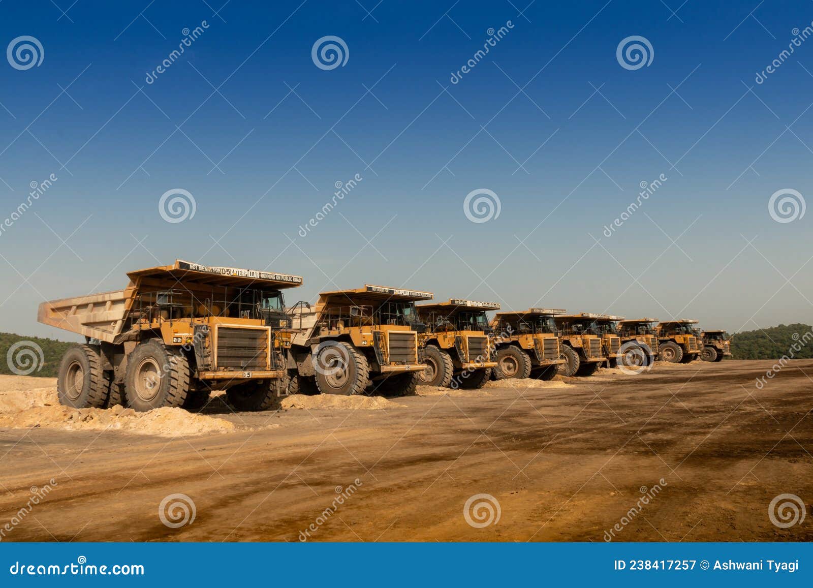 A fleet of huge dumpers editorial photography. Image of industry ...