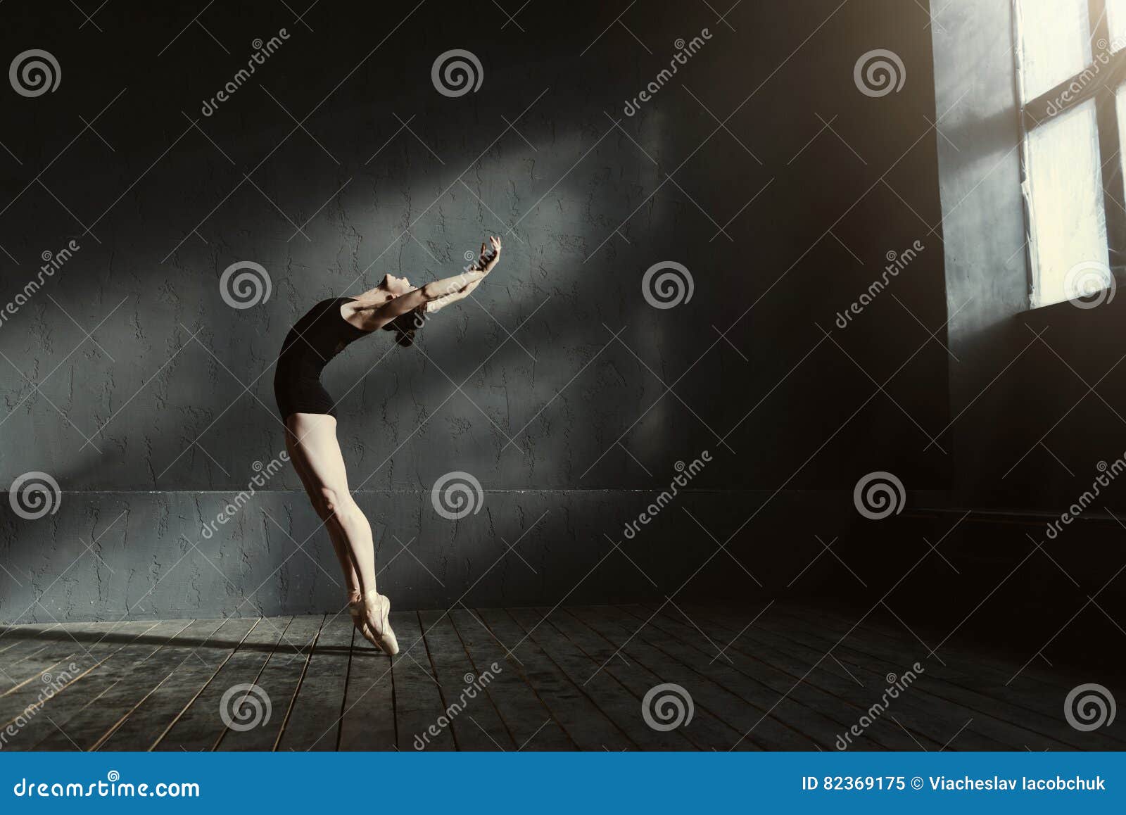 Flexible Ballet Dancer Stretching in the Dark Lighted Studio Stock ...
