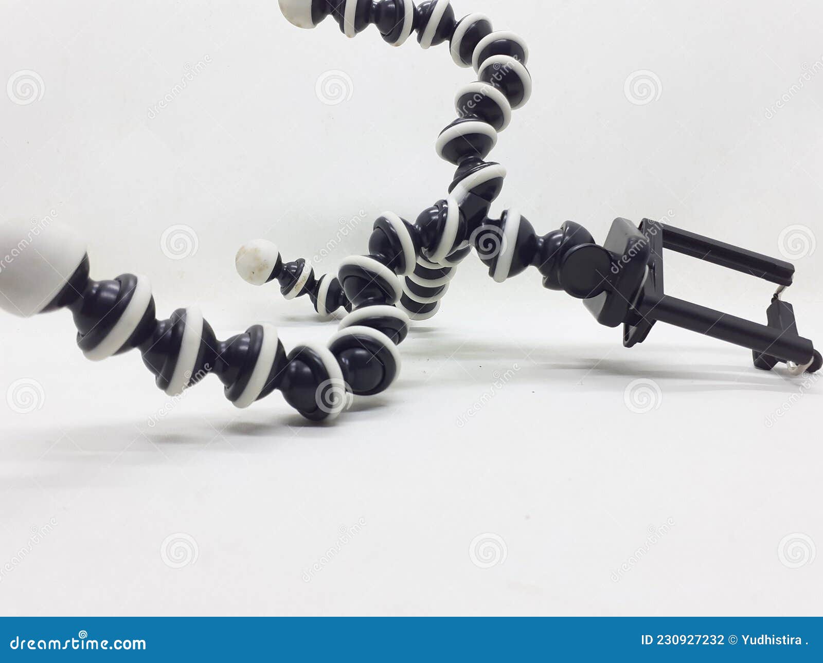 A Flexible Detachable Phone and Camera Stand on White Isolation ...