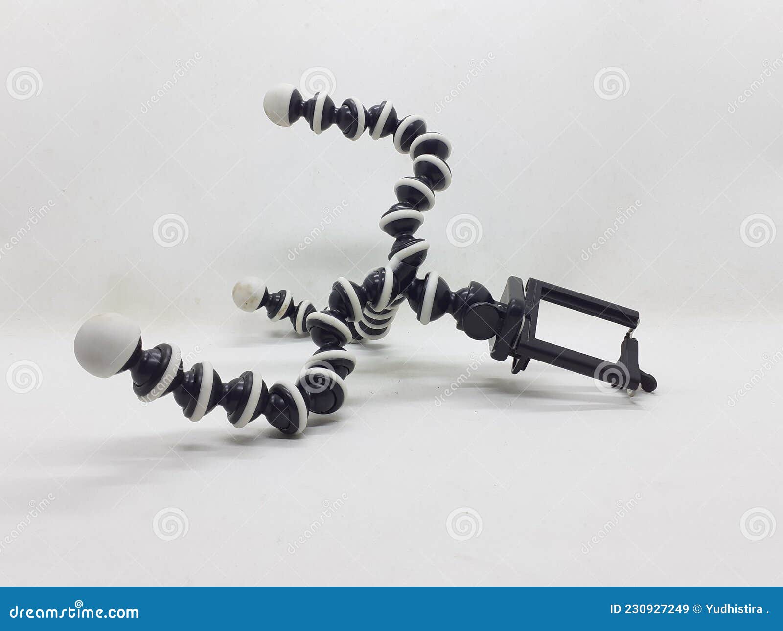 A Flexible Detachable Phone and Camera Stand on White Isolation ...