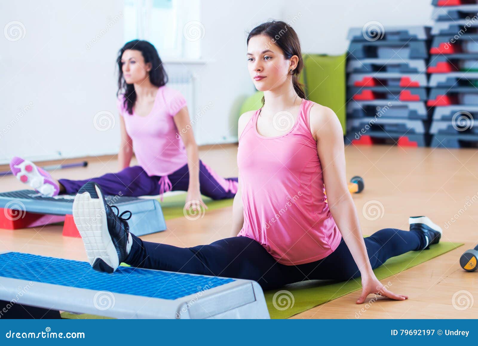Flexible Fit Women Stretching Legs With Aerobic Step Platforms. Royalty ...