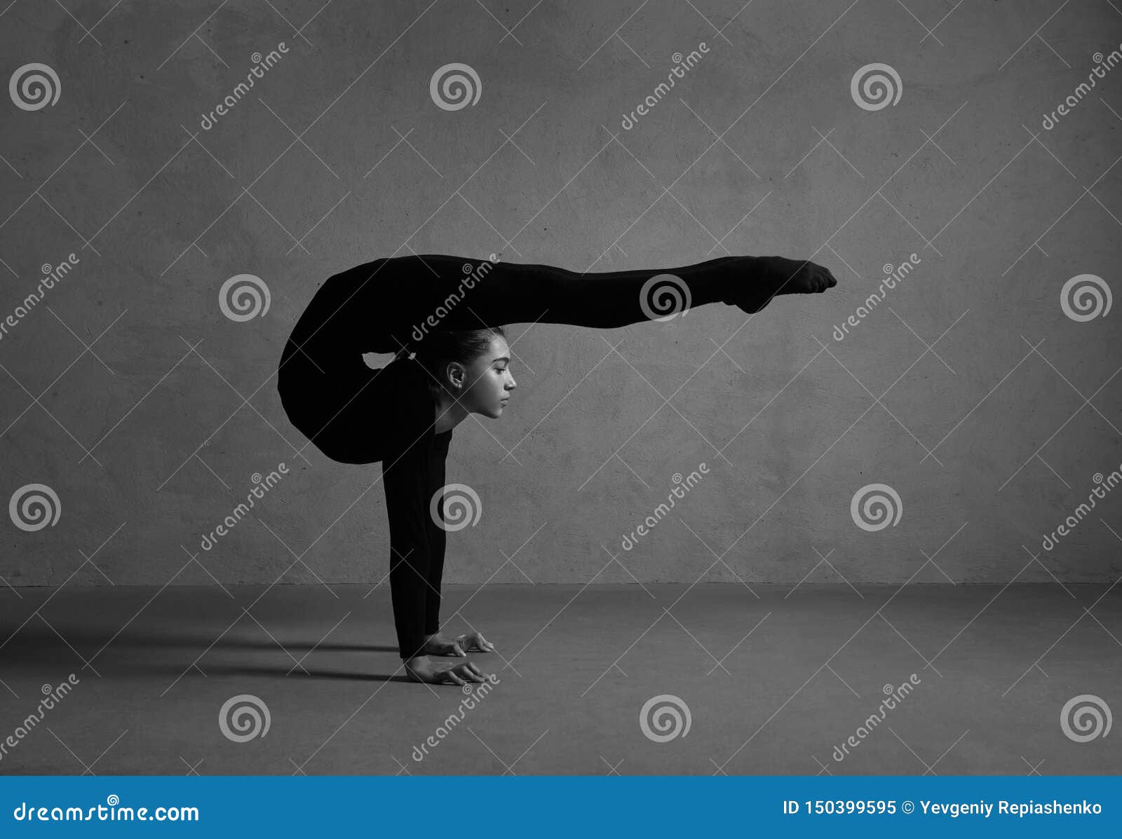 Flexible Gymnast Girl In A Beautiful Pose On A Background Of Apocalyptic Landscape In The Desert