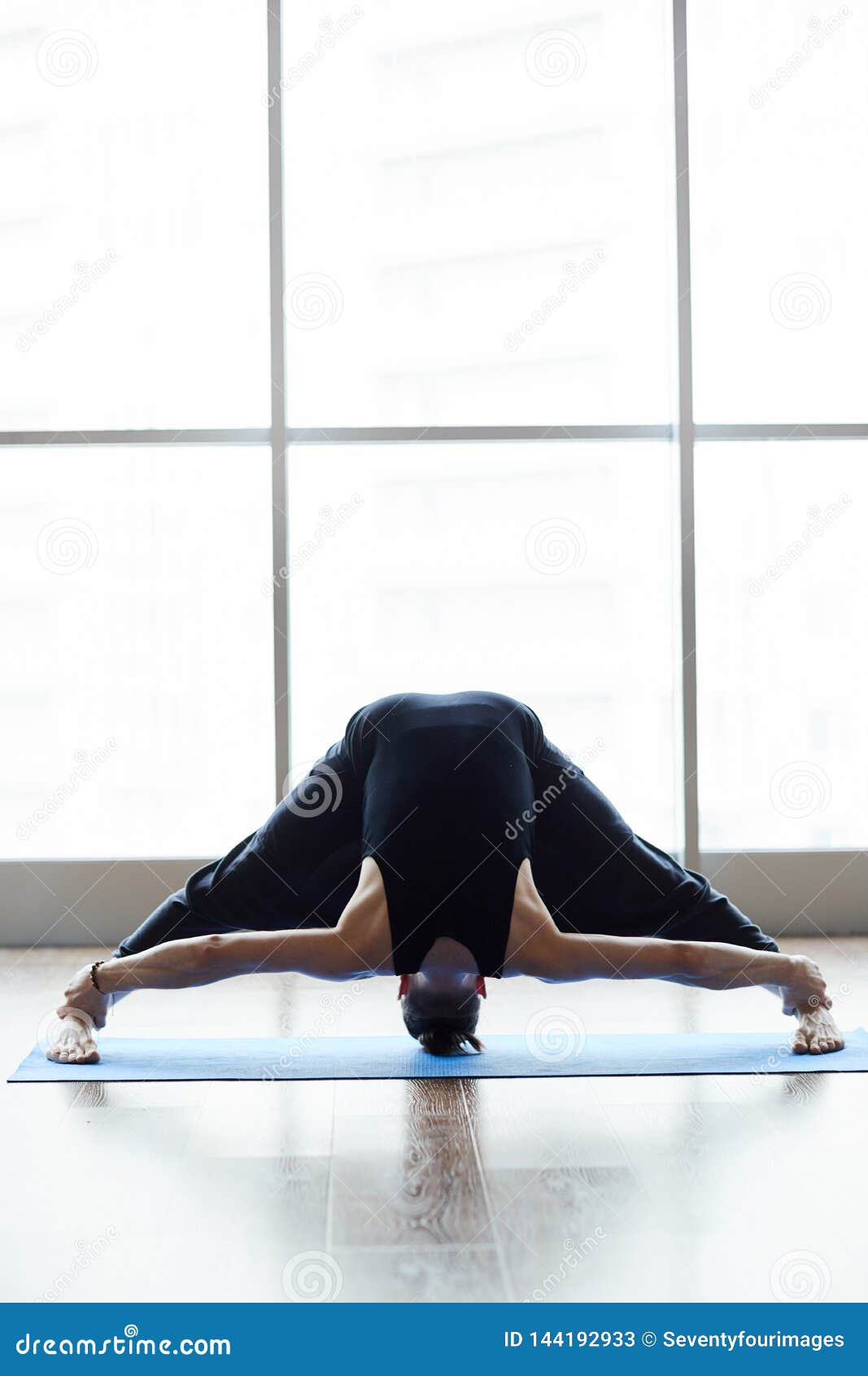 Wide-legged Standing Forward Bend Stock Image - Image of skill ...