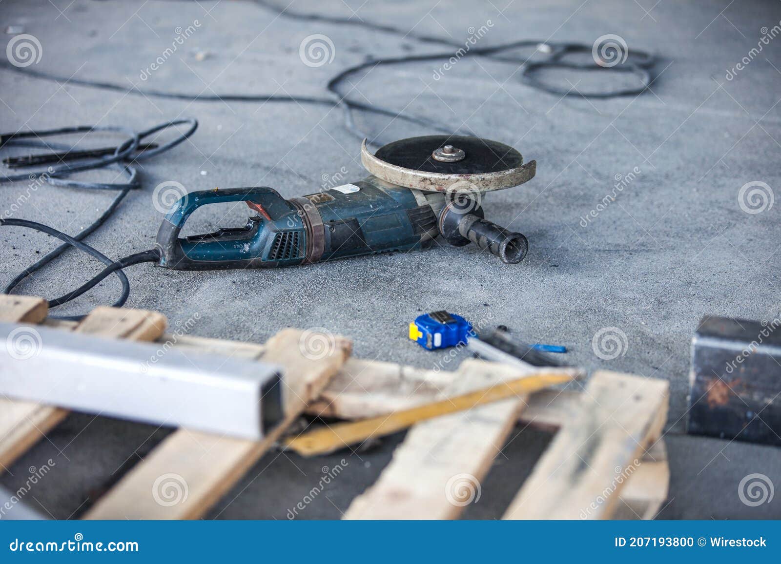A Flexible Retractable Measure Tape and Angle Grinder Tool at the ...