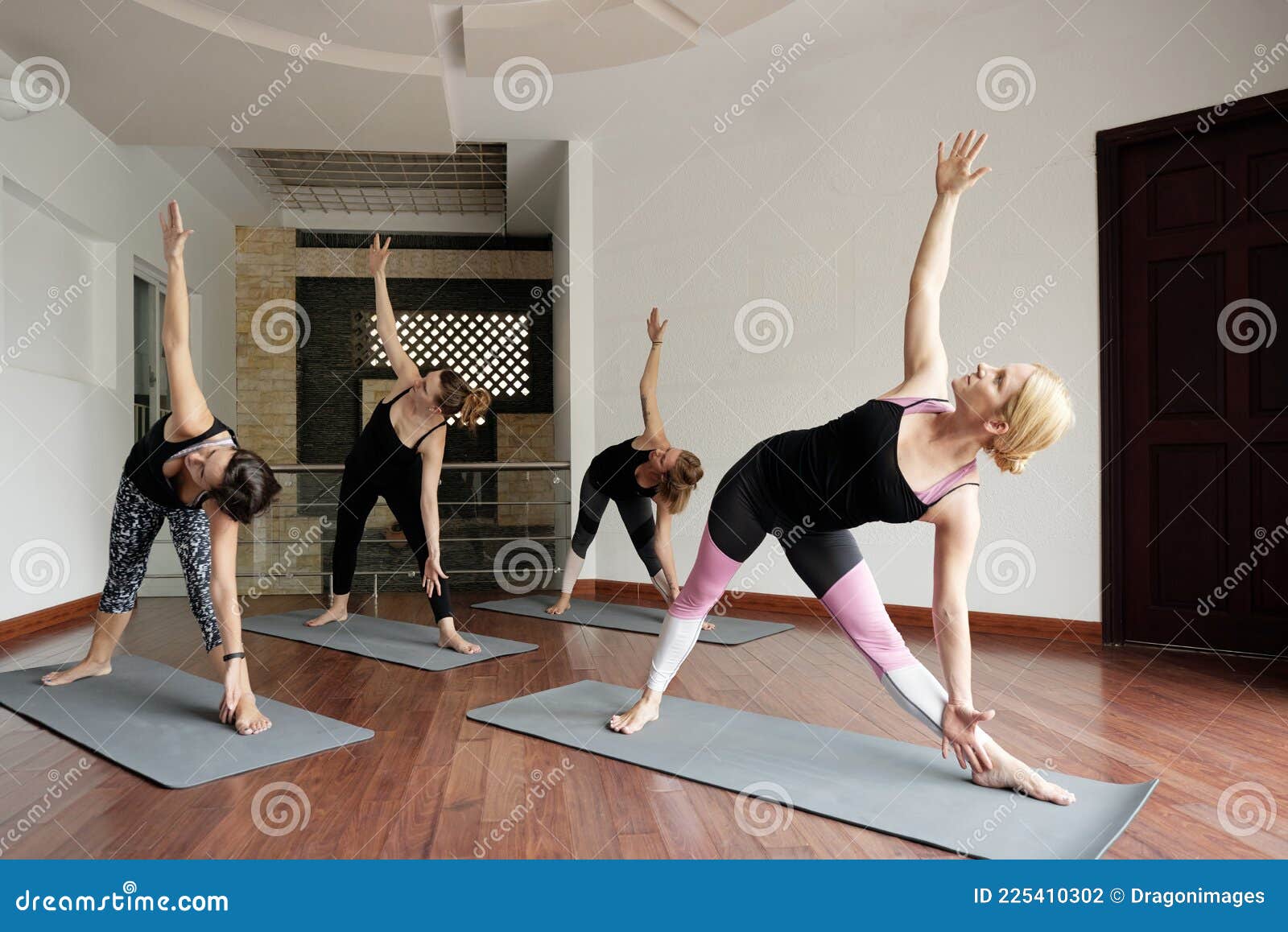 Flexible Women Doing Triangle Pose Stock Photo - Image of fitness ...