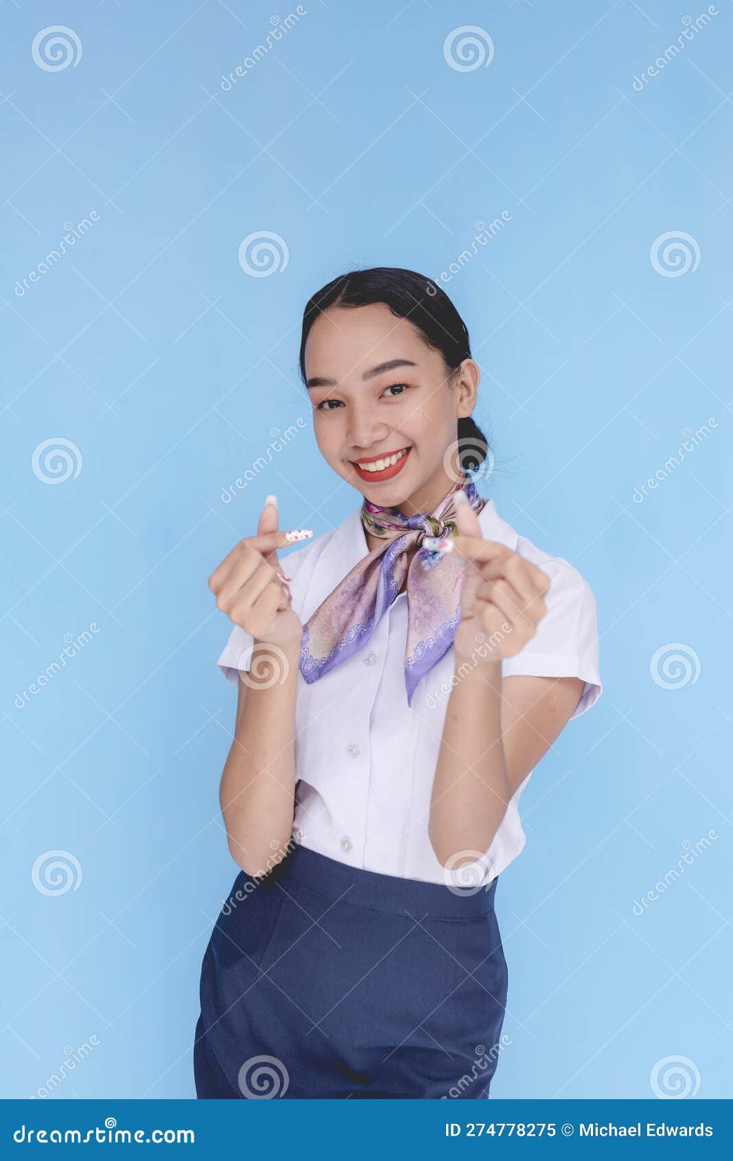 A Flight Attendant Showing Affection And Love By Doing The Finger Heart
