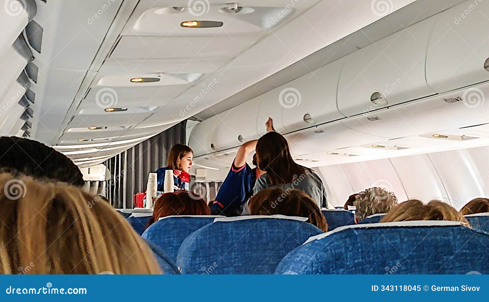 Flight Attendants Serve Passengers on the Airplane Editorial Image ...