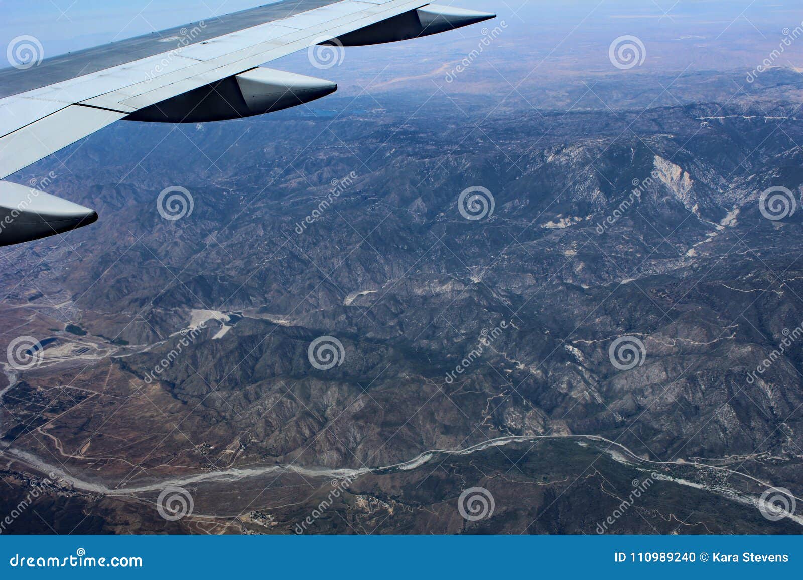 Flight Passes Over Dark Mountains Stock Photo - Image of flying ...