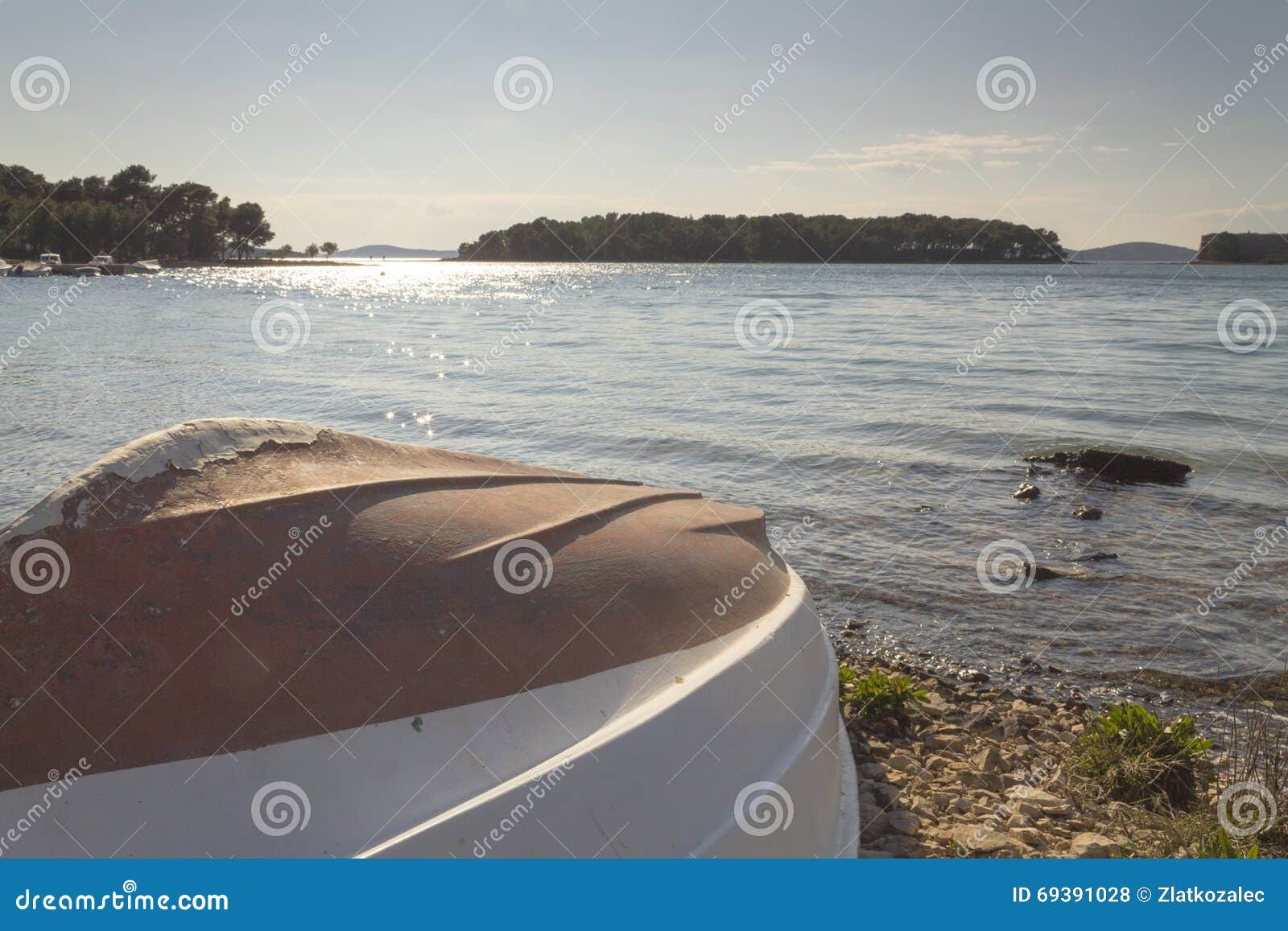 Flipped boat on a coast stock photo. Image of sunny, white - 69391028