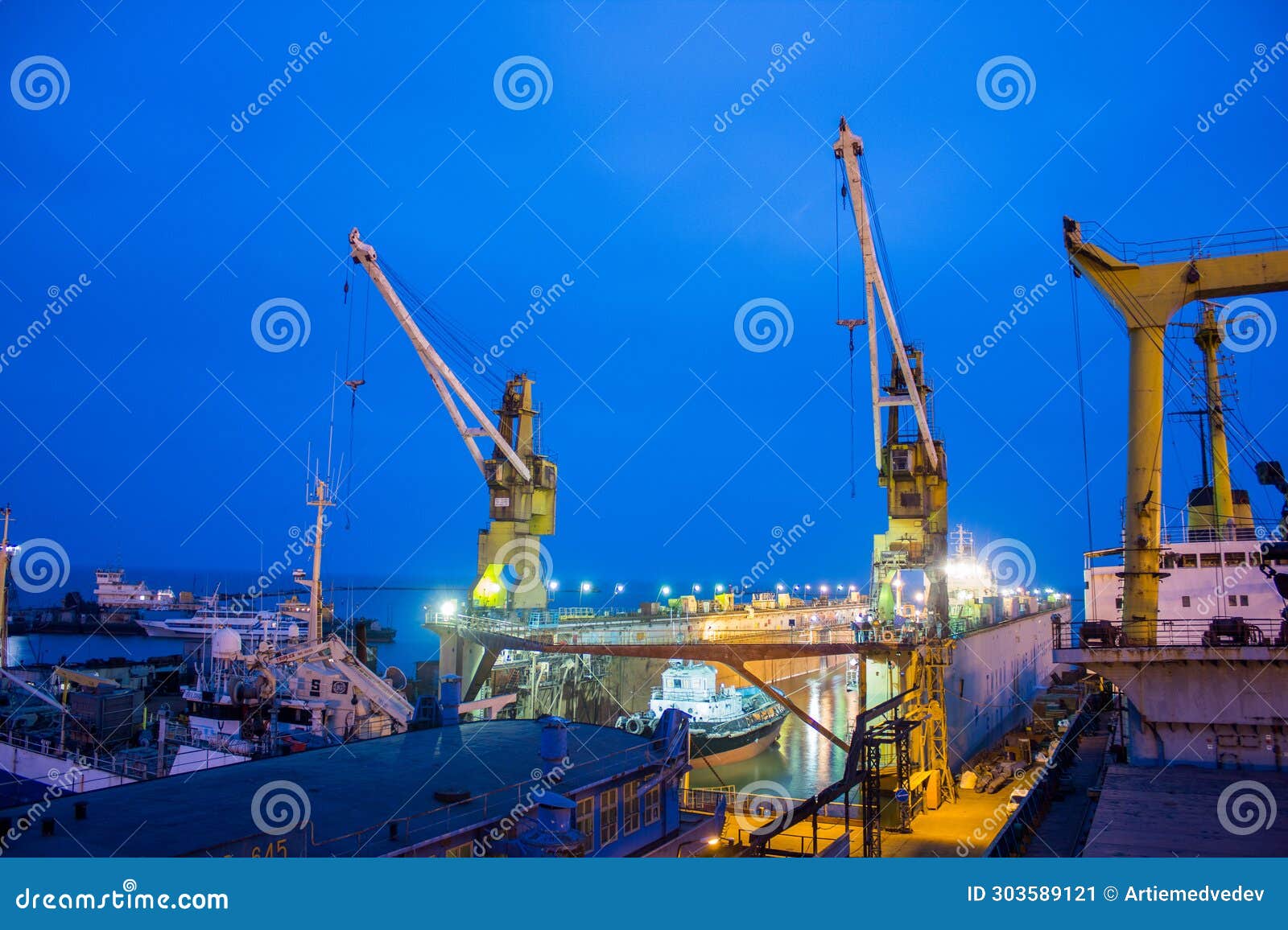 Floating Dock in Shipyard at Dusk, Vessels Undergoing Repair ... Floating Dock in Shipyard at Dusk, Vessels Undergoing Repair ...