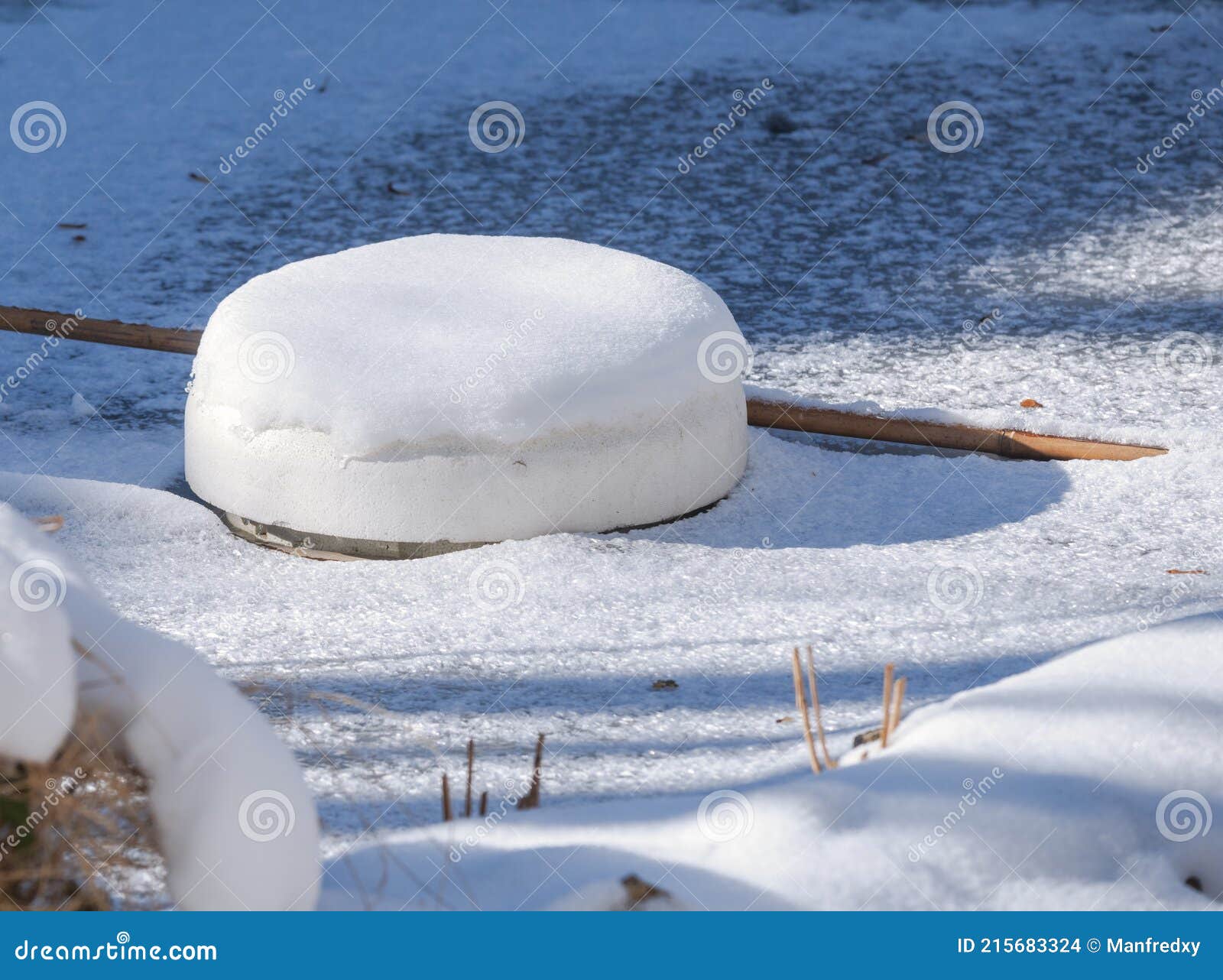 Floating Ice Preventer in a Frozen Pond Stock Photo - Image of water ...