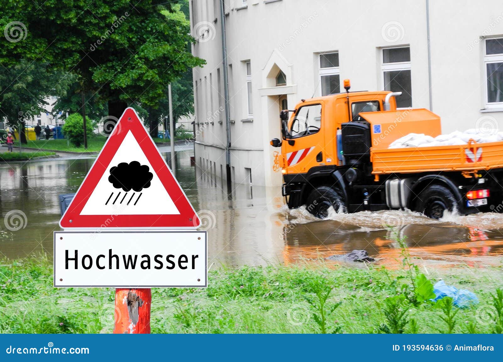 Flood Warning Sign Submerged In Rising Water With Stormy Background ...