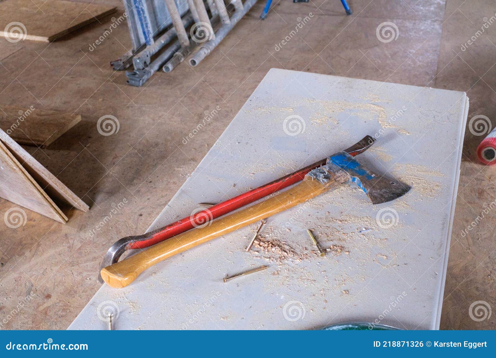 On the Floor of a Construction Site Lies an Axe and Next To it a Chisel ...