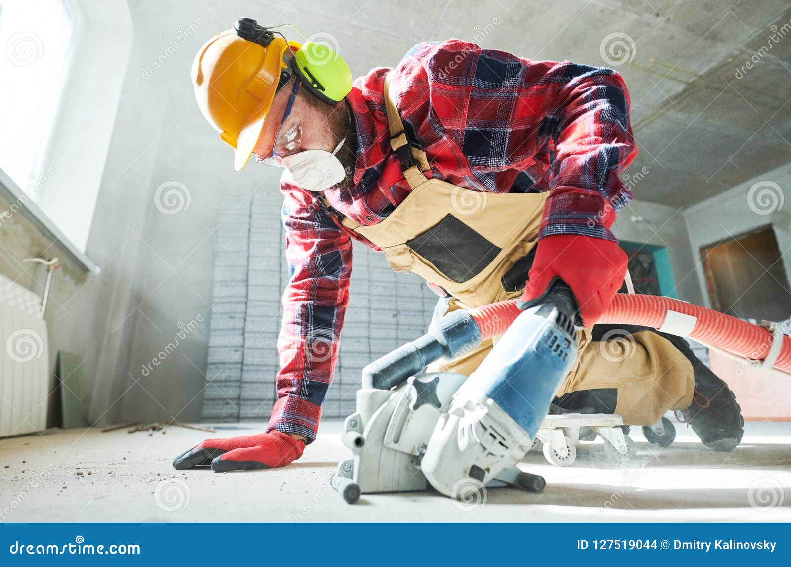 Builder at Work. Cutting Concrete Floor for Cabling by Diamond Slitting ...