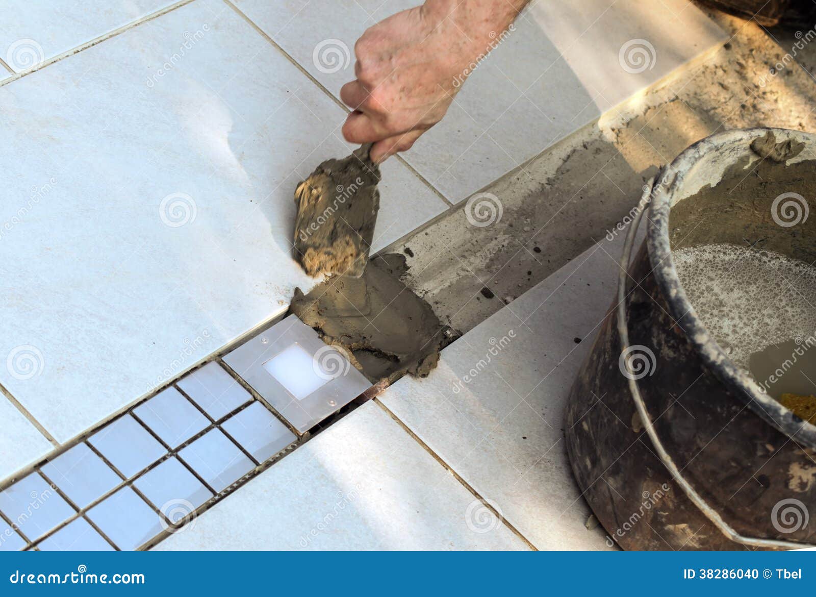 Floor tiler filling cement stock photo. Image of cutting - 38286040