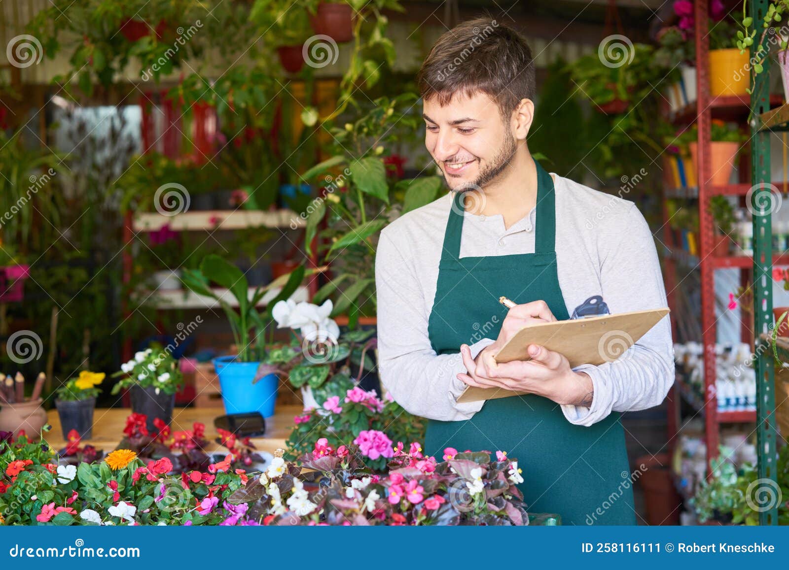Florist with Clipboard Doing Inventory in Flower Shop Stock Image ...