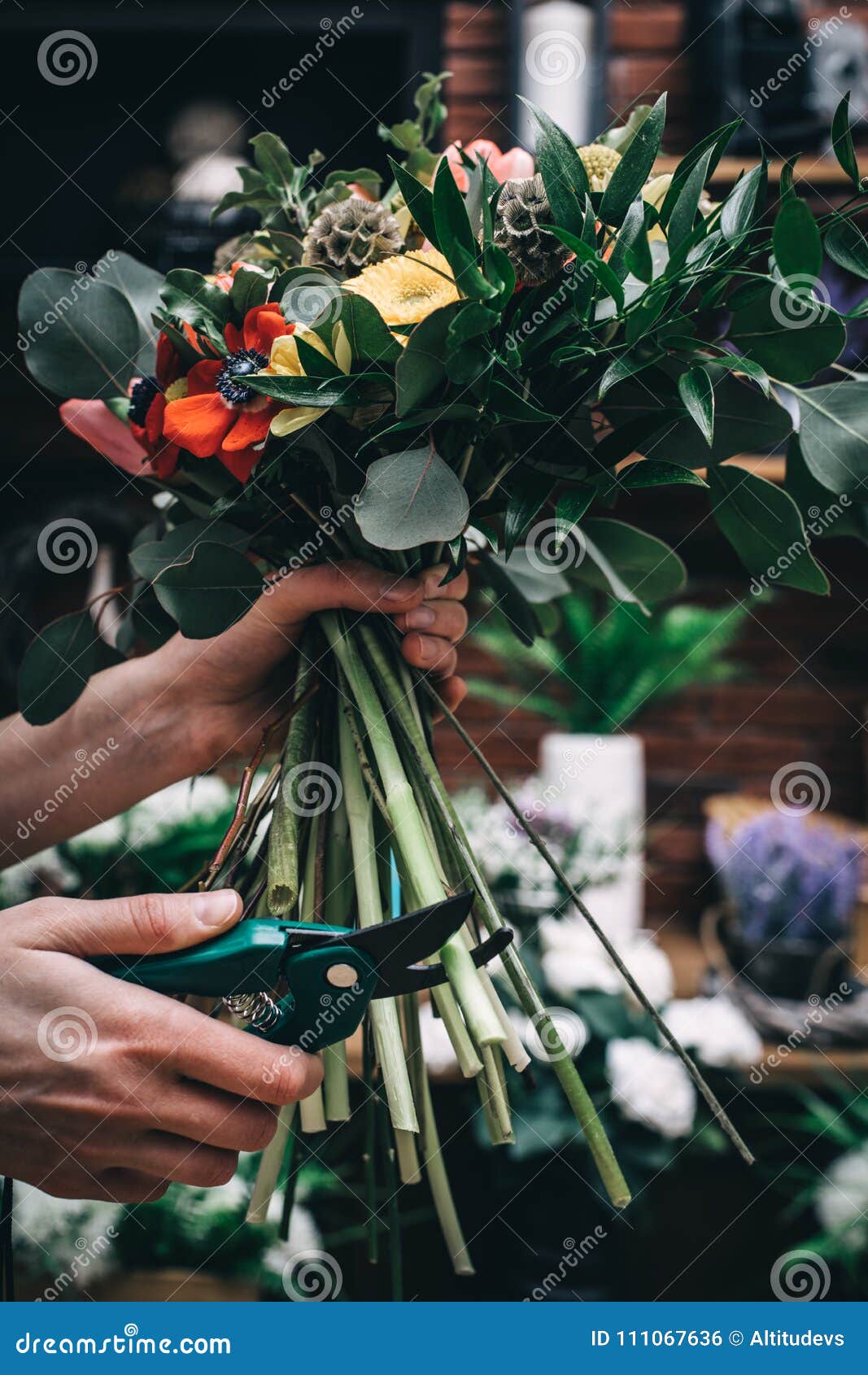 Florist cuts a bouquet stock photo. Image of horizontal - 111067636