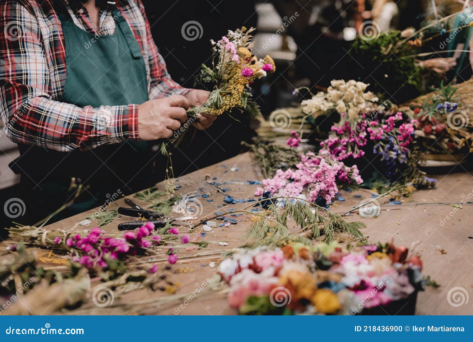 Florist Working on a Bouquet of Flowers in Front of a Table with Tools ...