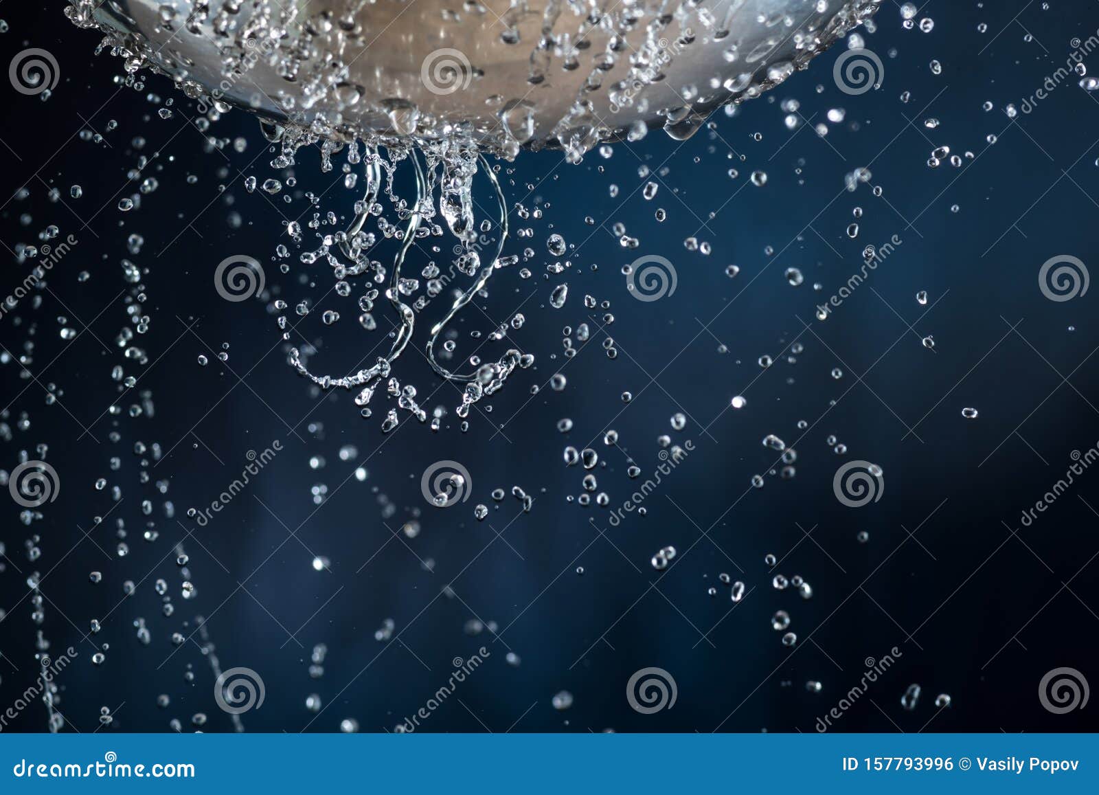 Flow and Drops of Water through Holes in a Colander on a Dark ...