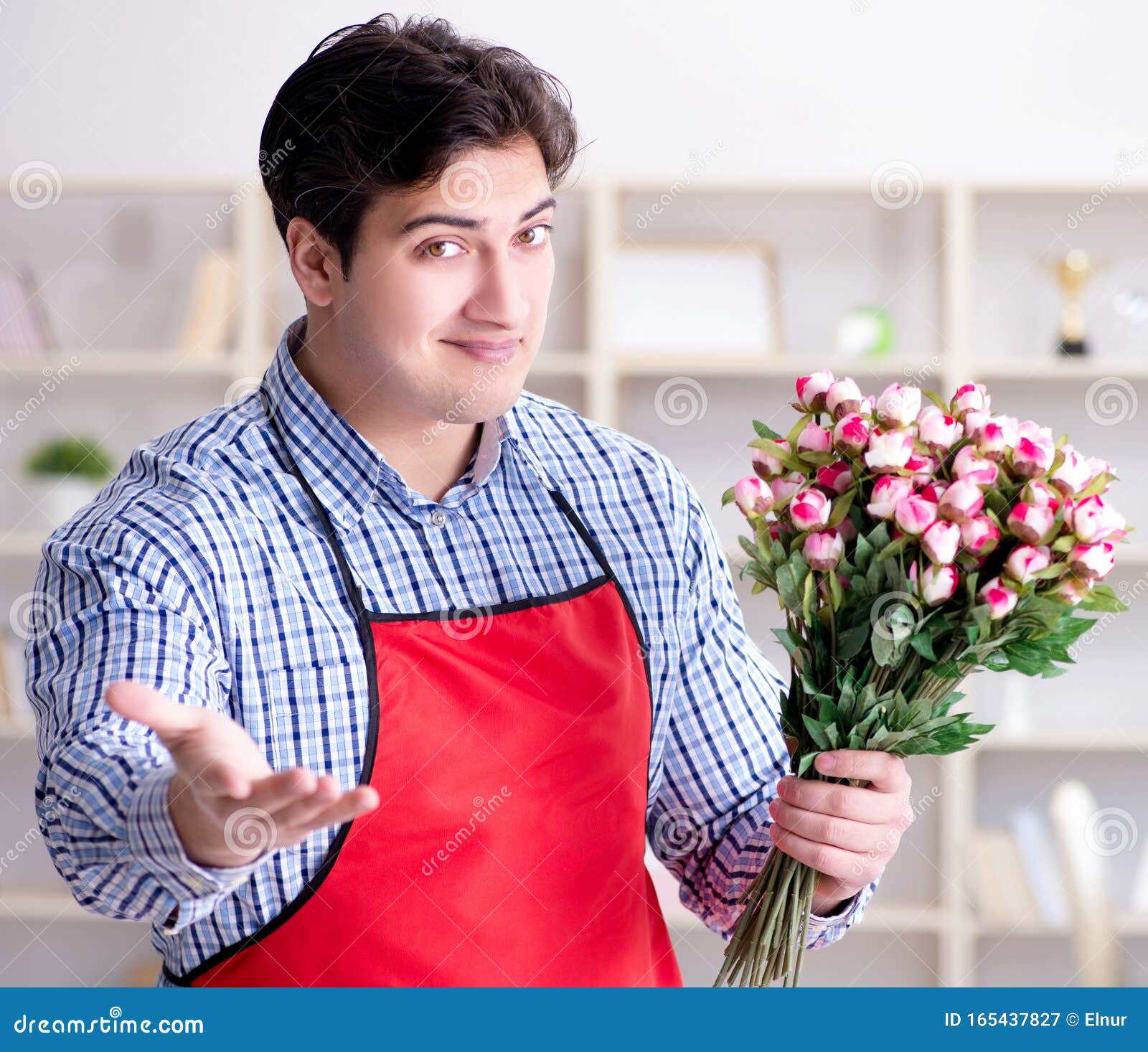Flower Shop Assistant Offering a Bunch of Flowers Stock Image - Image ...