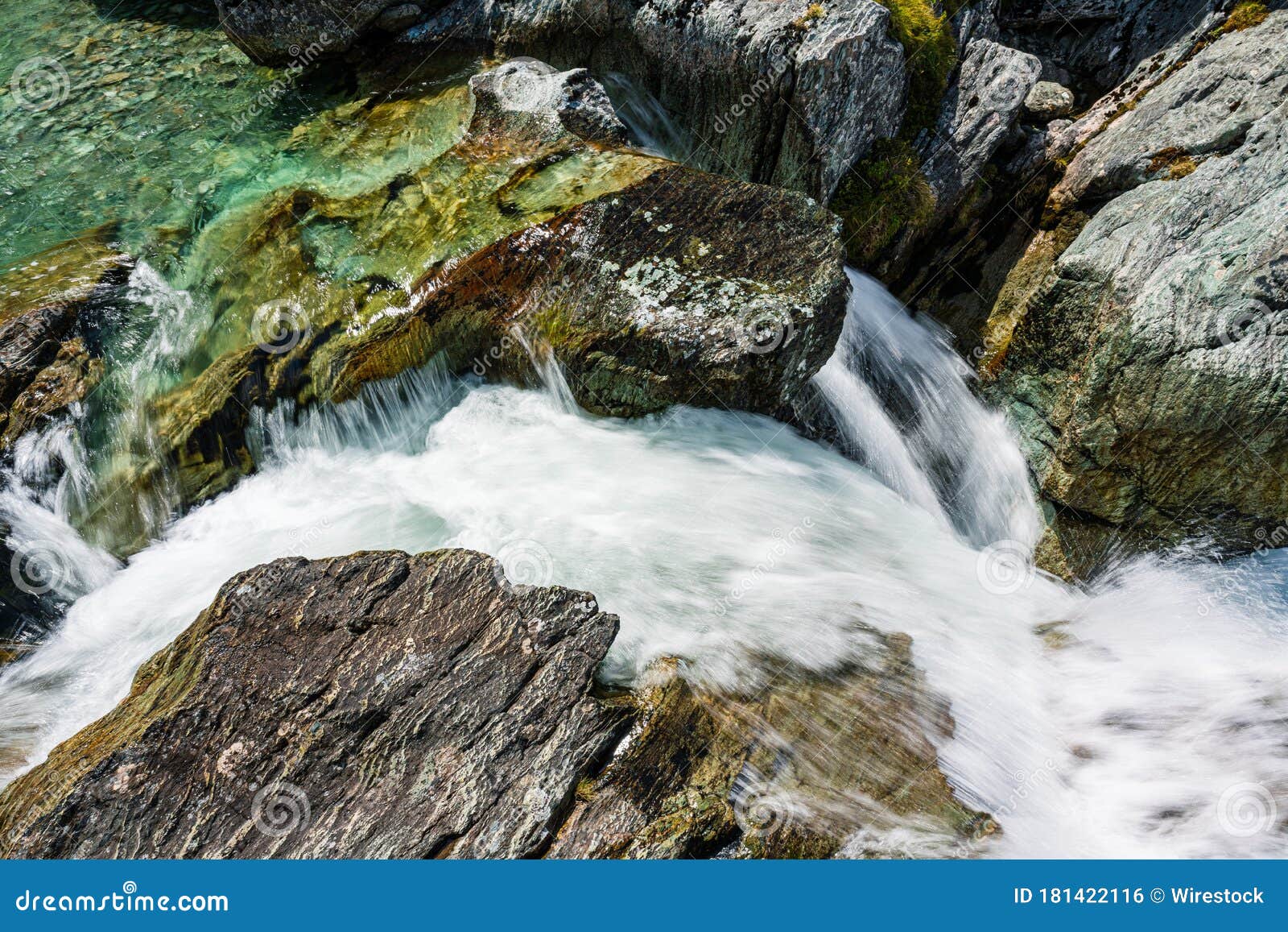 Flowing River Surrounded by Rocks Under the Sunlight at Daytime ...