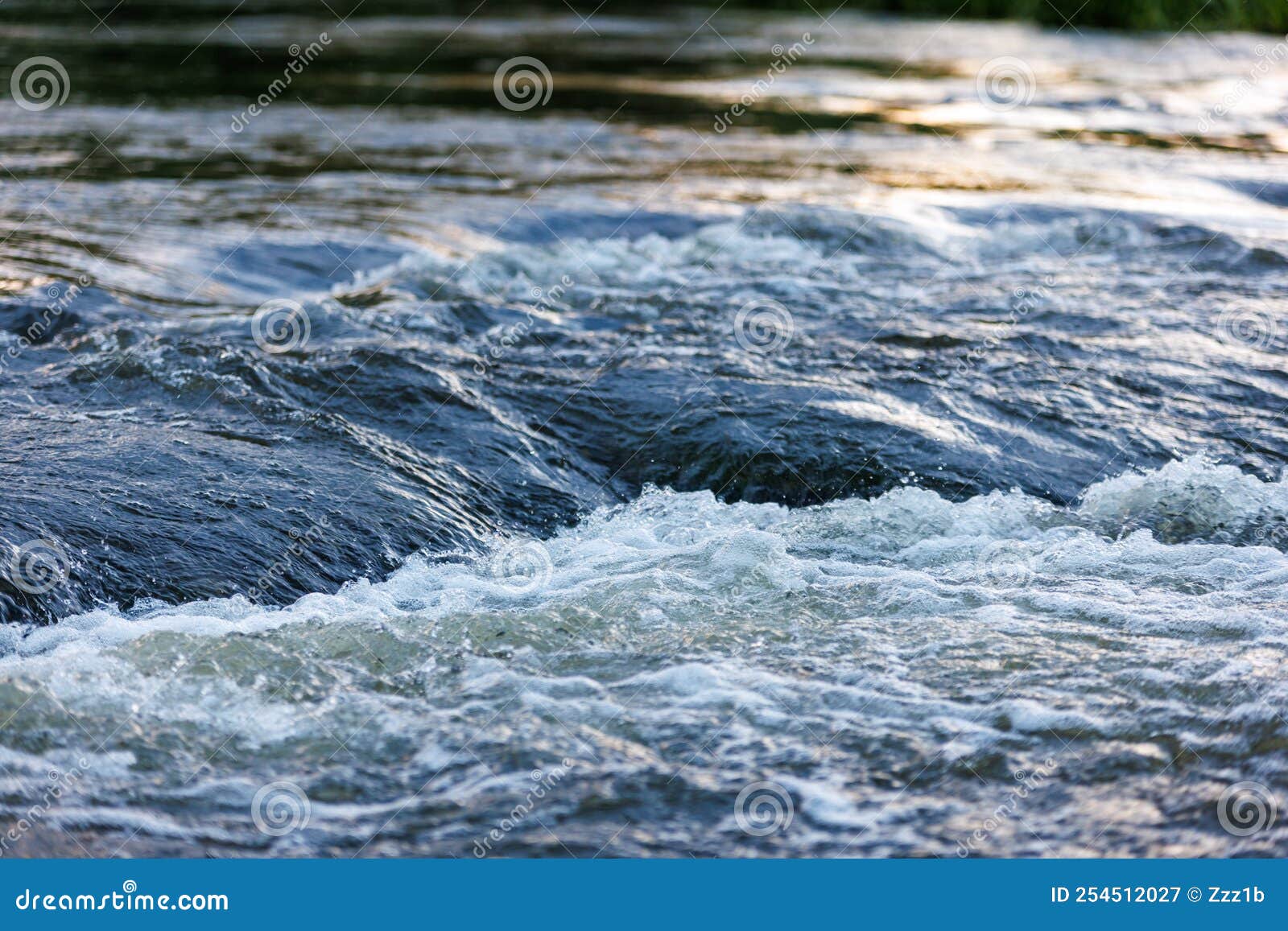 Flowing Water of a Summer River with a Small Rapid Waterfall at Evening ...