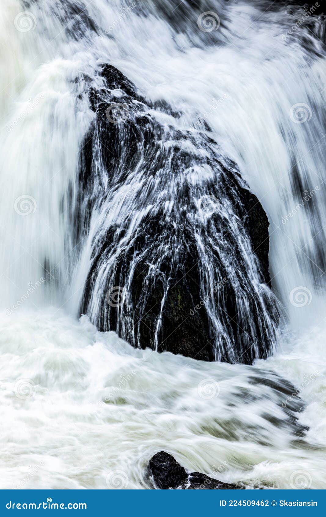 Flowing Waterfall in Blurry Motion Over Black Rock Stock Photo - Image ...