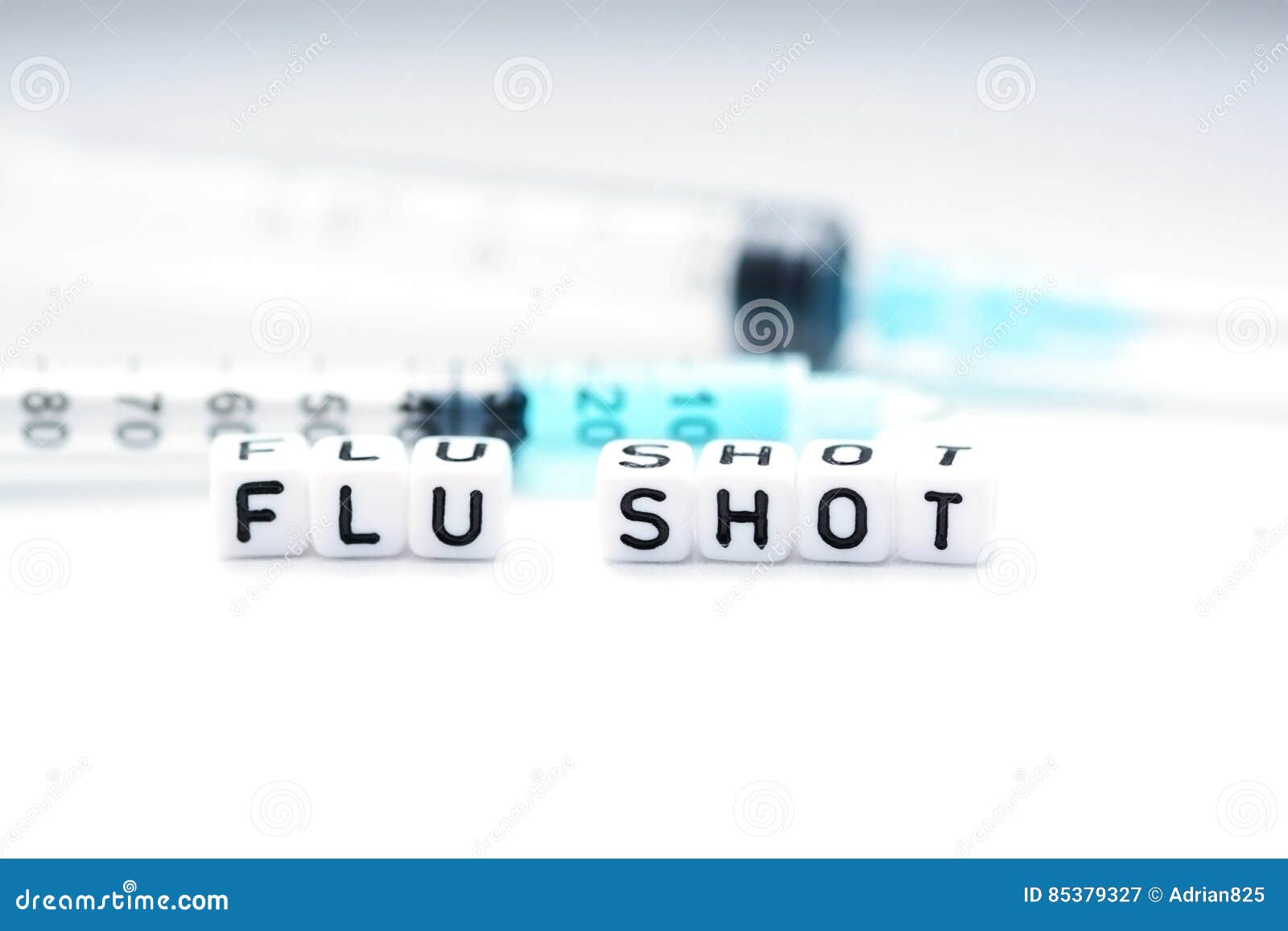 Flu Shot Text Spelled with Tiled Letters Standing Next To a Syringe ...