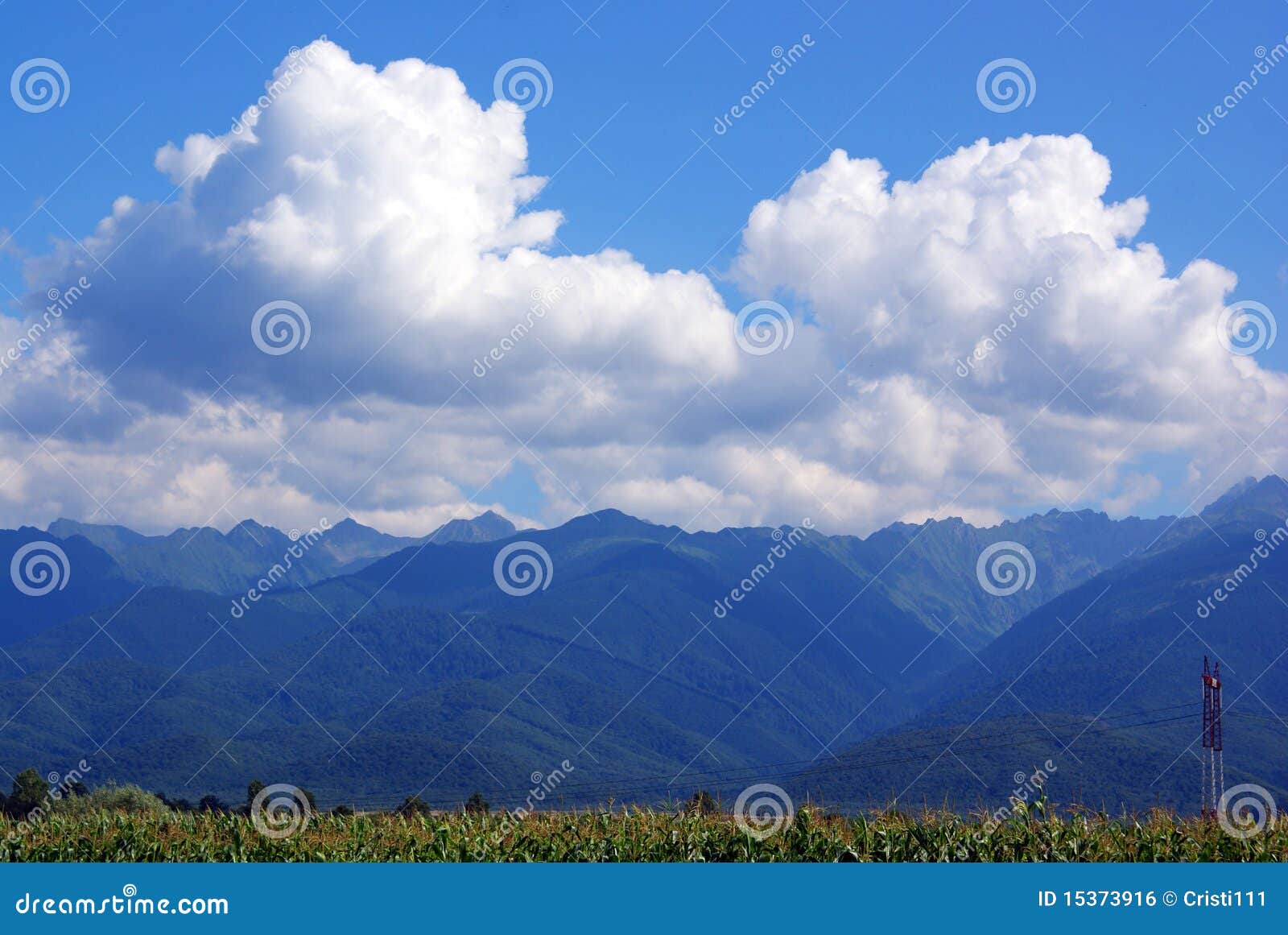 Fluffy Clouds Over Far Mountains Stock Photo - Image of meadow, clouds ...