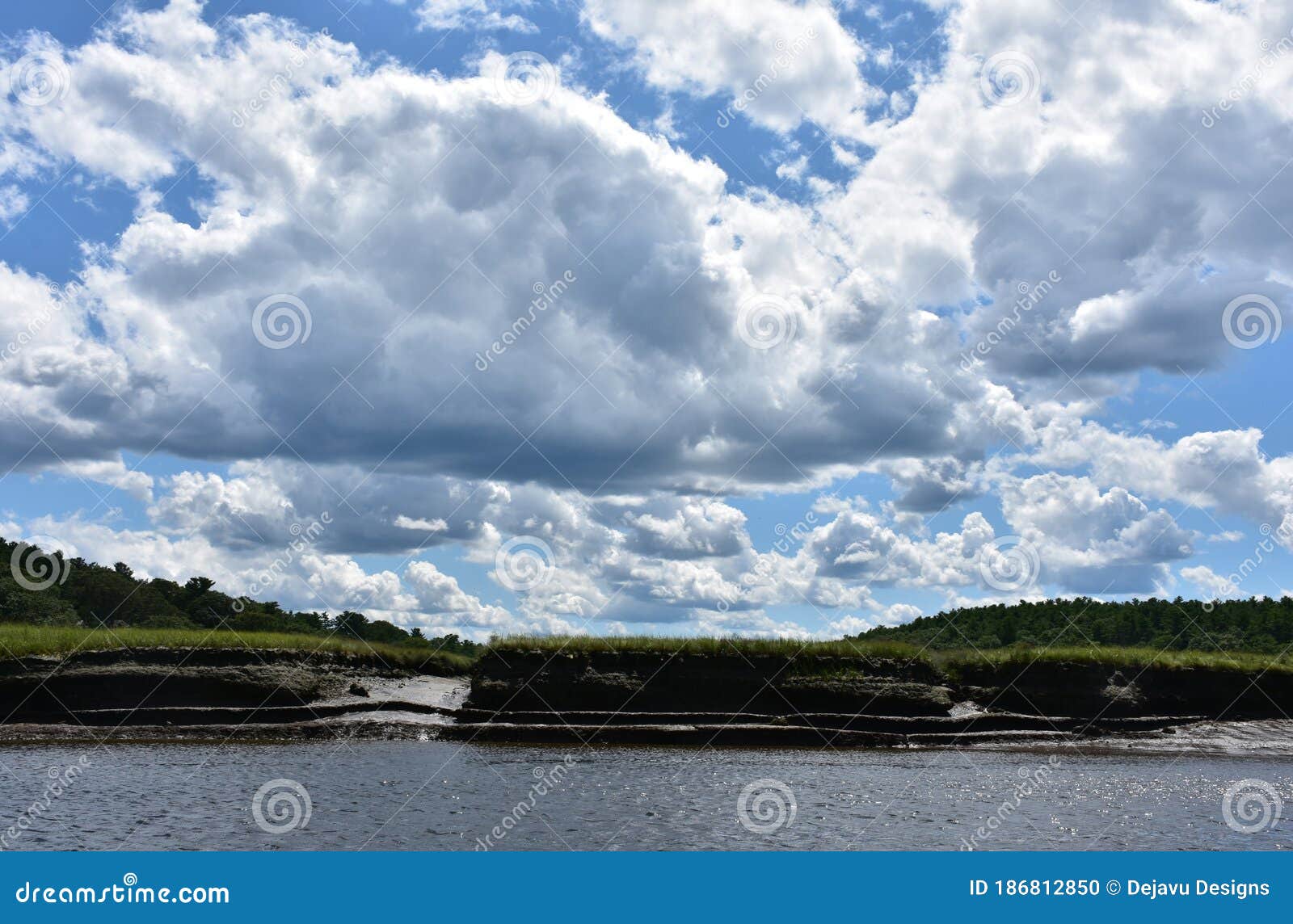 Fluffy White Clouds Hanging Over Marsh Grass Stock Photo - Image of ...