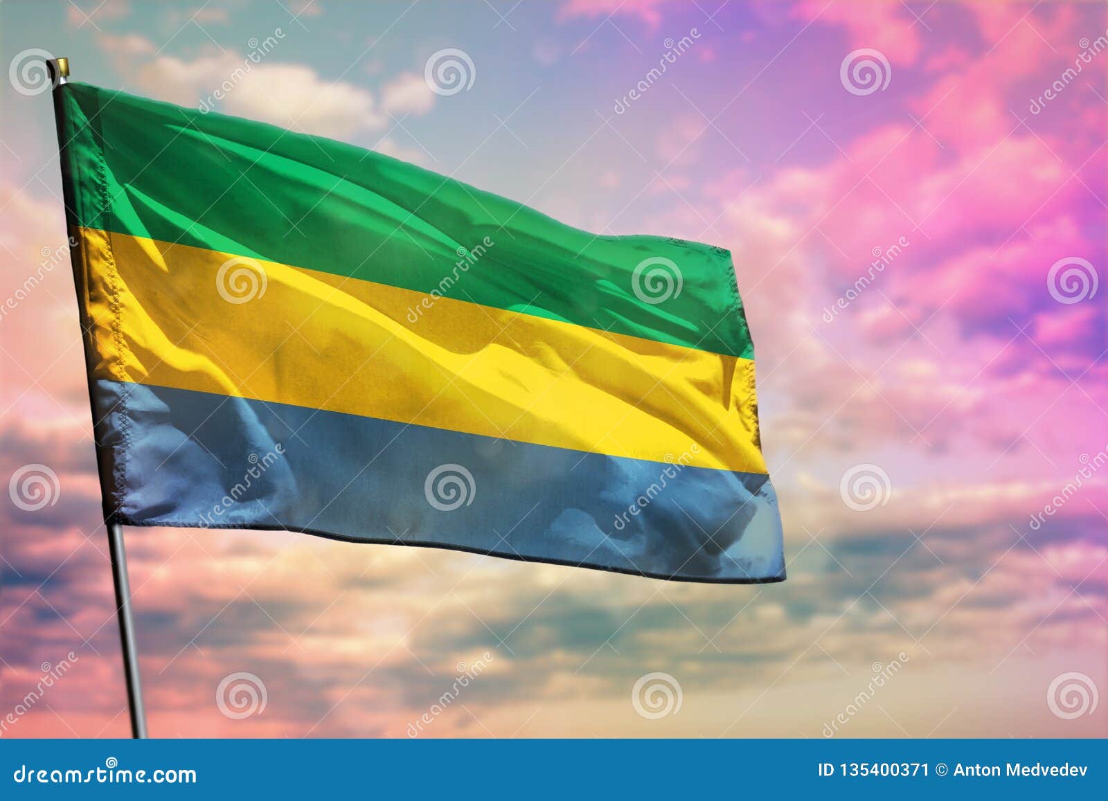 Fluttering Gabon Flag on Colorful Cloudy Sky Background. Prosperity ... Fluttering Gabon Flag on Colorful Cloudy Sky Background. Prosperity ...
