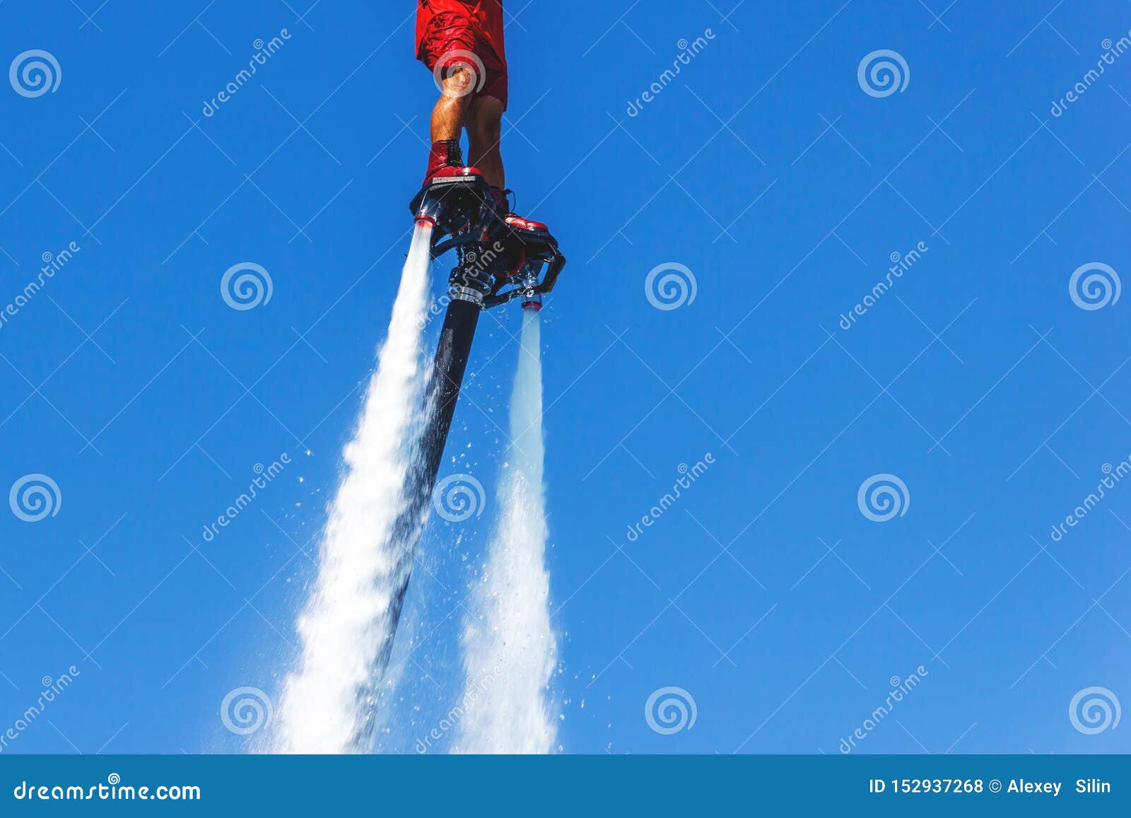 Athlete With A Jetpack Soars Over Black Sea. Two Powerful Jets Of Water ...