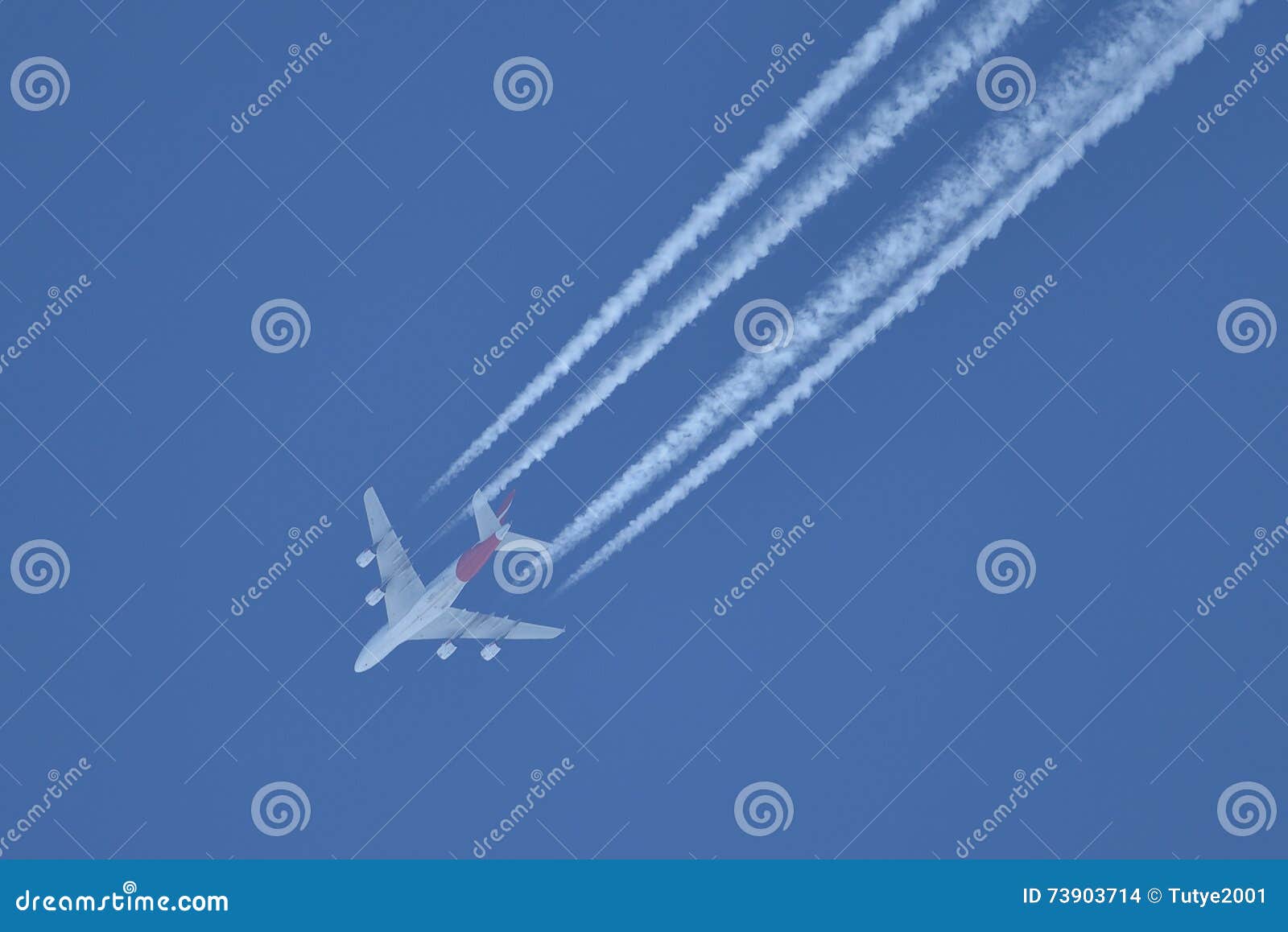 Flying Airplane on the Blue Sky Leaving White Lines Behind Stock Photo ...