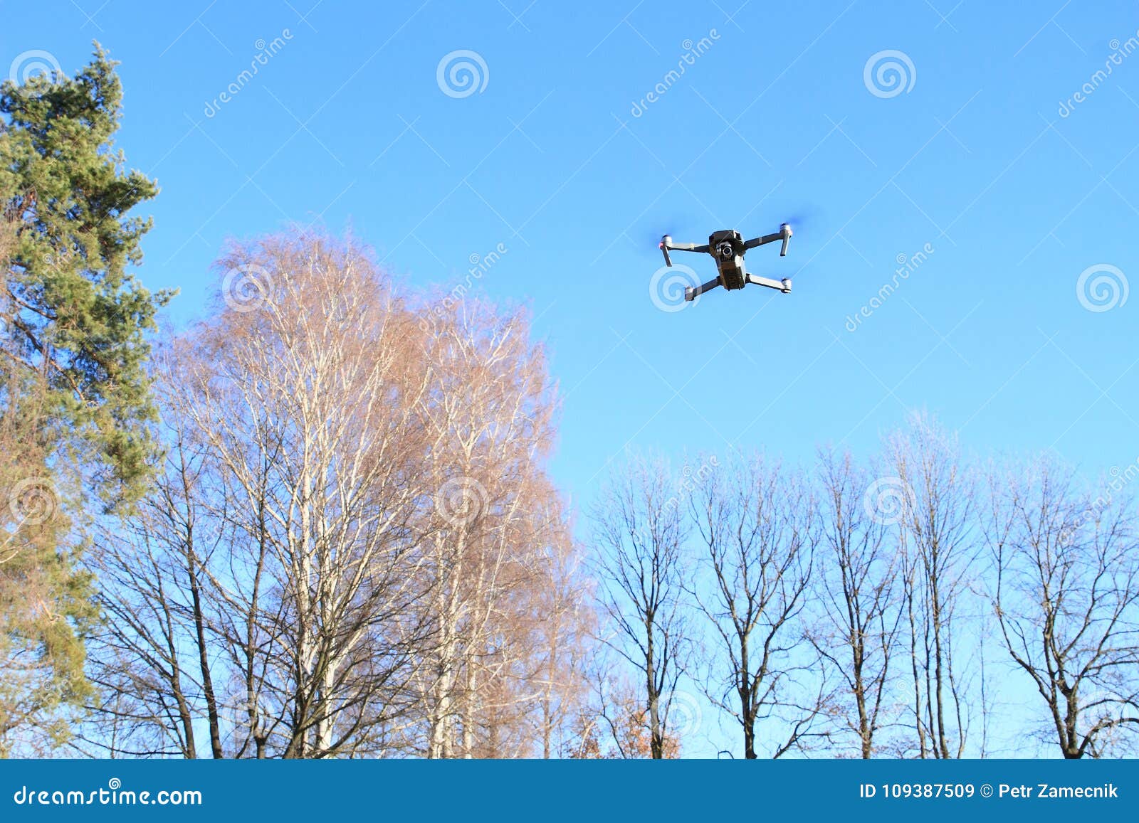 Flying drone with camera stock image. Image of trees - 109387509