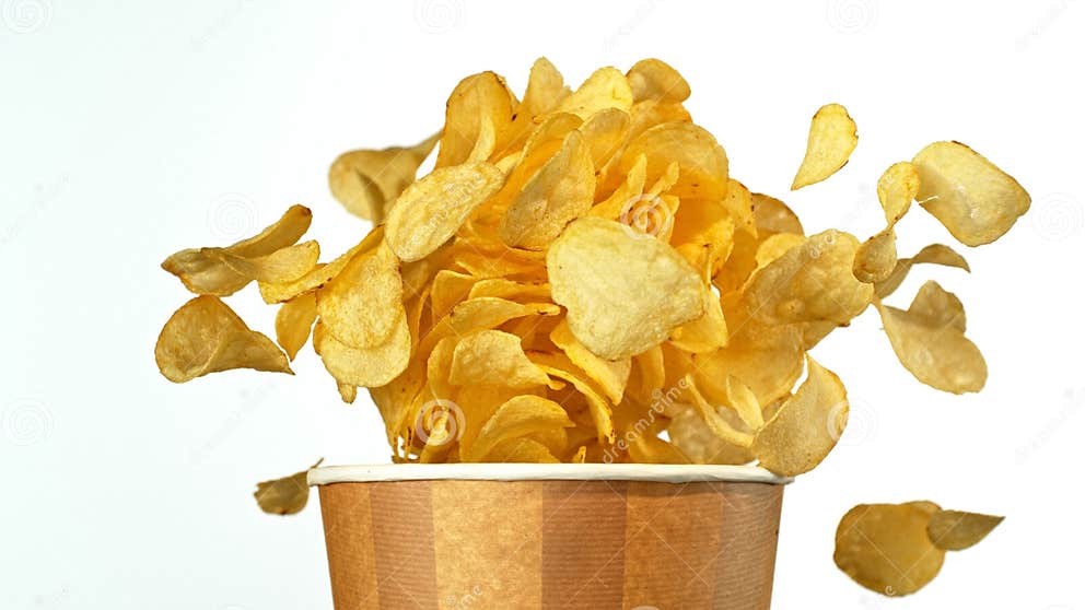 Flying Fried Potato Chips Exploding from Paper Bucket. Stock Photo ...