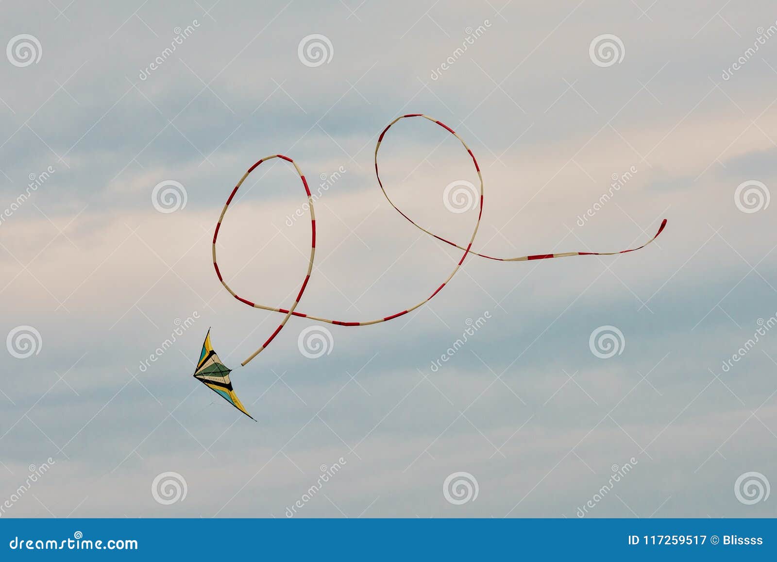 Flying Kite Making Loops on Cloudy Sky Background Stock Image - Image ...