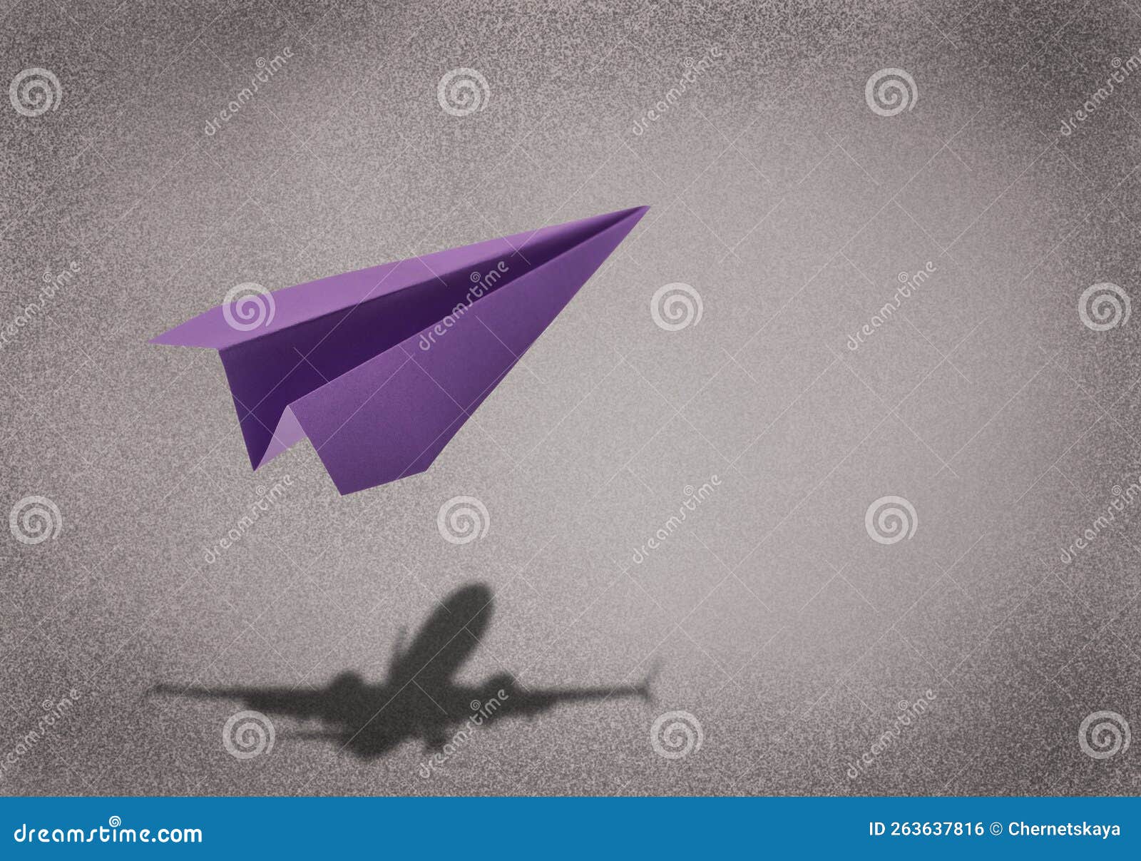 Flying Paper Plane and Shadow of a Real Airplane on Grey Background ...