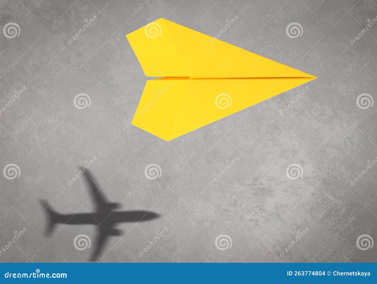 Flying Paper Plane and Shadow of a Real Airplane on Grey Background ...