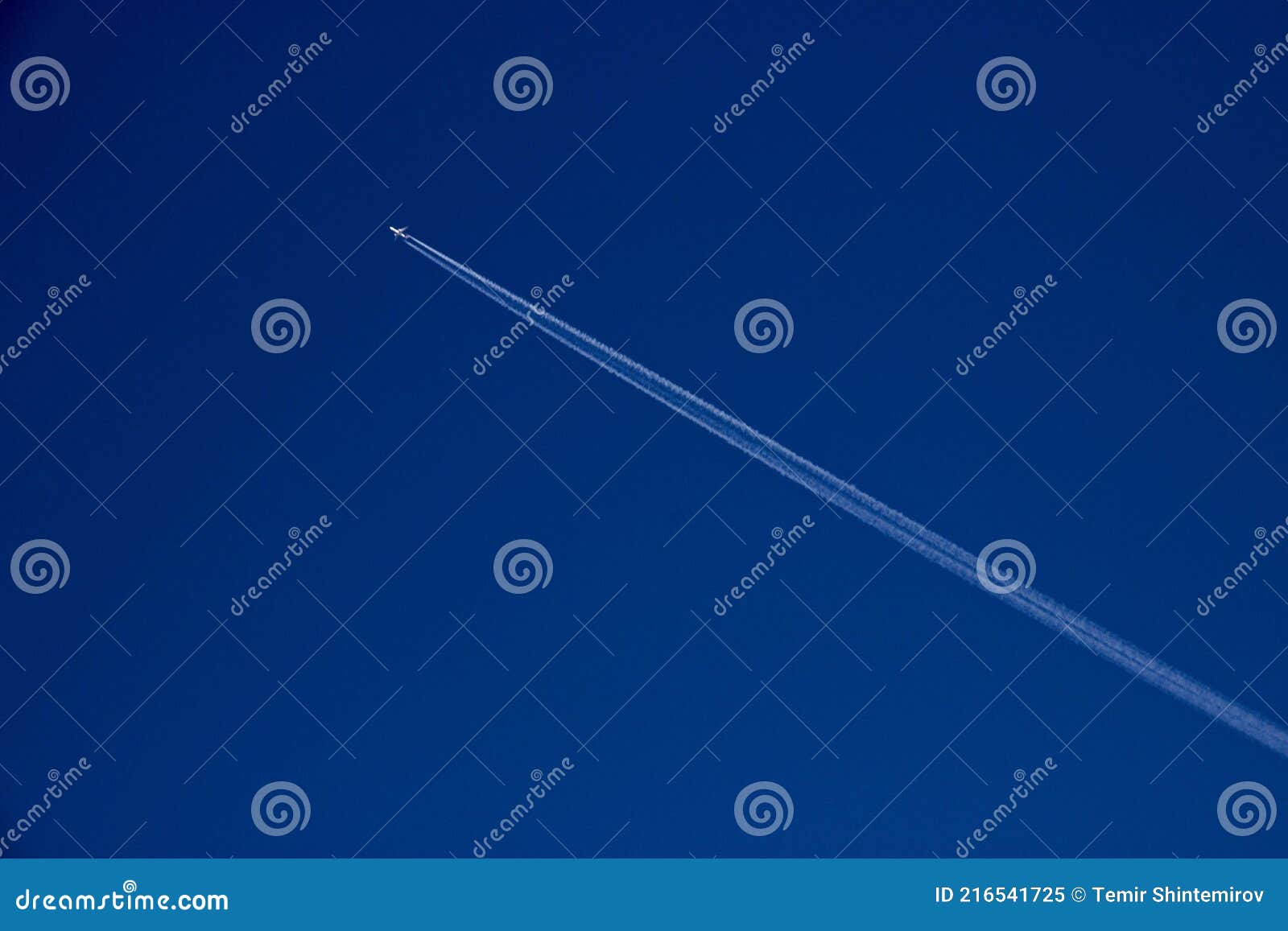 Flying Plane with an Inversion Track on a Blue Sky Background Stock ...